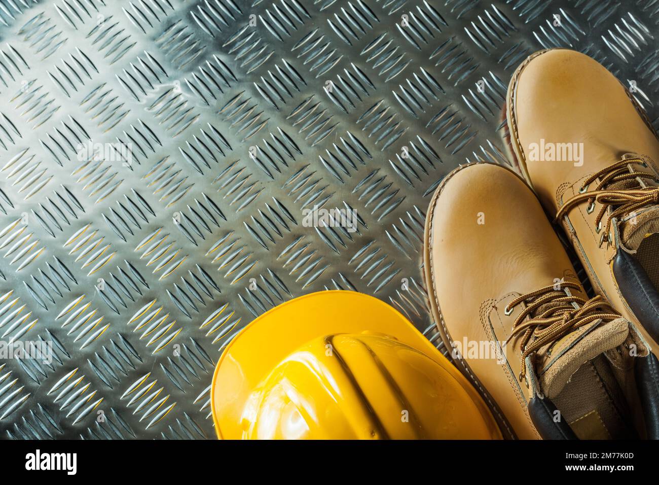 Waterproof boots hard hat on corrugated metal sheet Stock Photo - Alamy