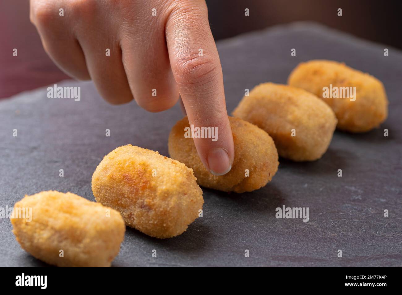 Woman taking tasty fried hi-res stock photography and images - Alamy