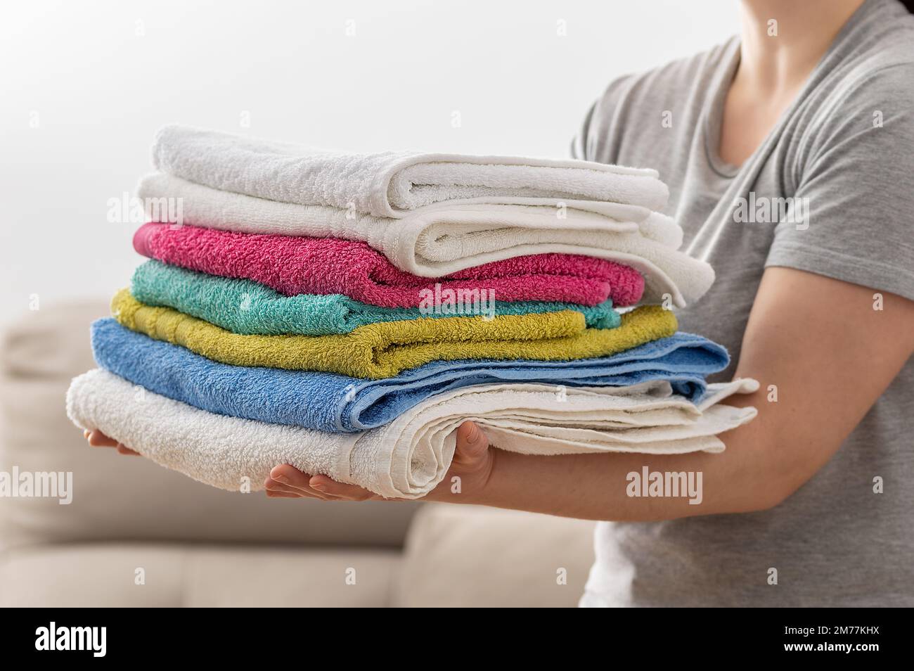 Woman pile of folded clothes hi-res stock photography and images - Alamy