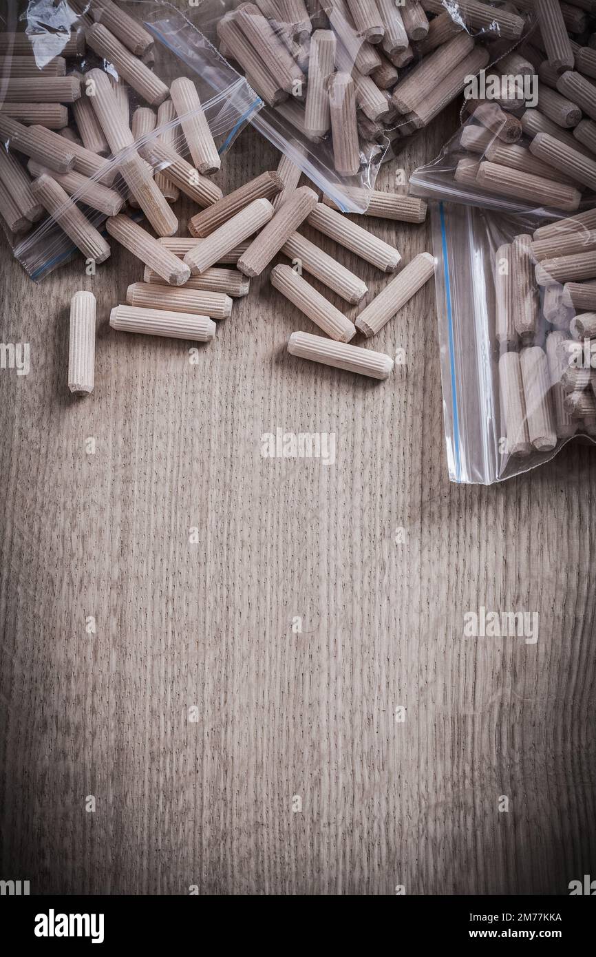 Wooden dowels on wood board copy space construction concept Stock Photo ...