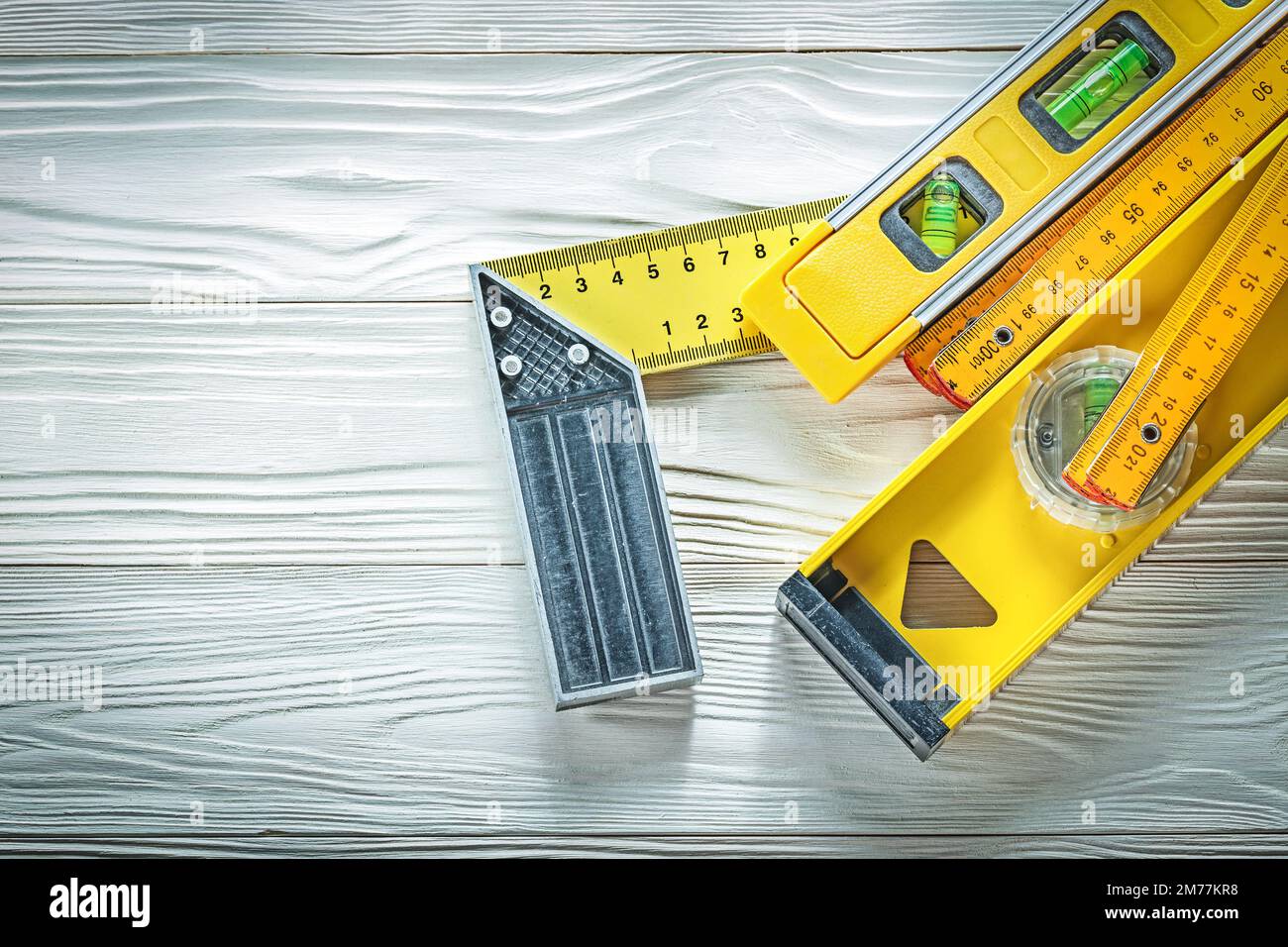 Wooden meter construction level try square on white board top view ...