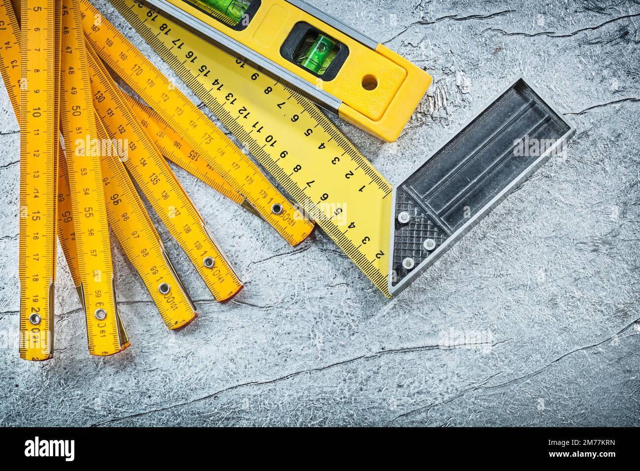Wooden meter construction level try square on metallic background ...