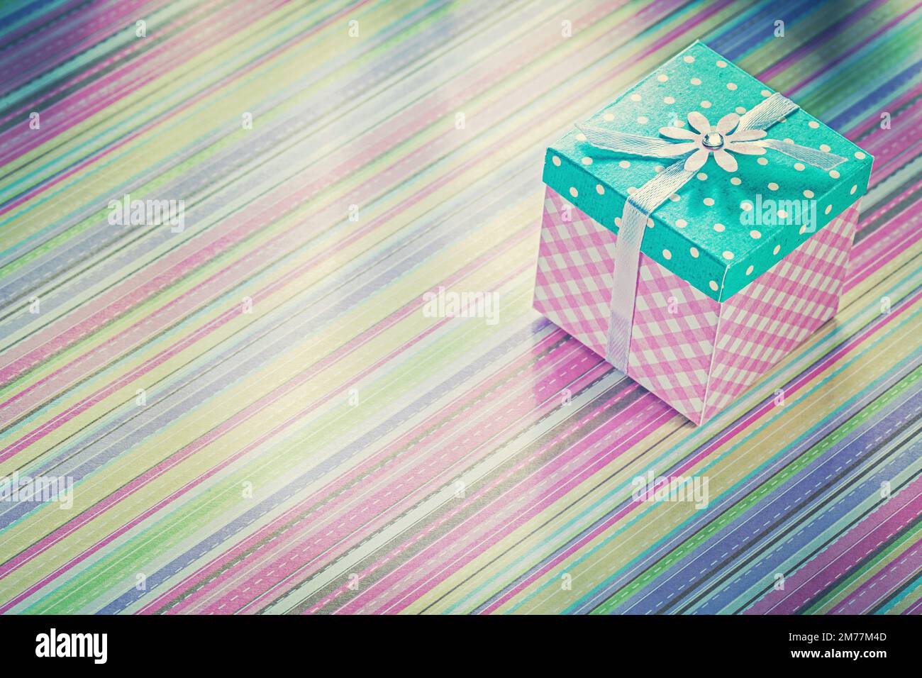 Wrapped present box on stripy fabric background holidays concept Stock ...