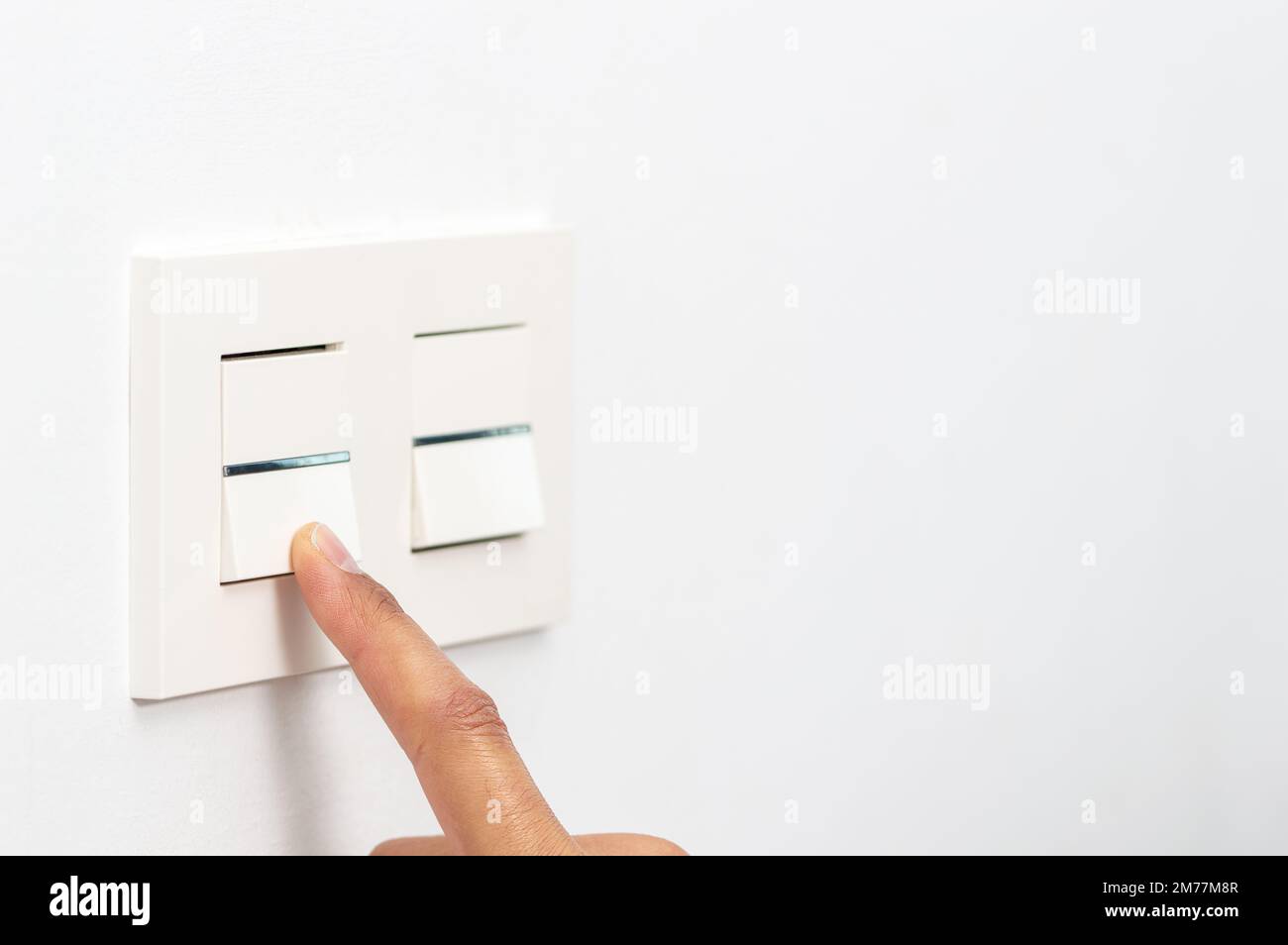 Close up the male hand or fingers turn on or off the white light switch ...