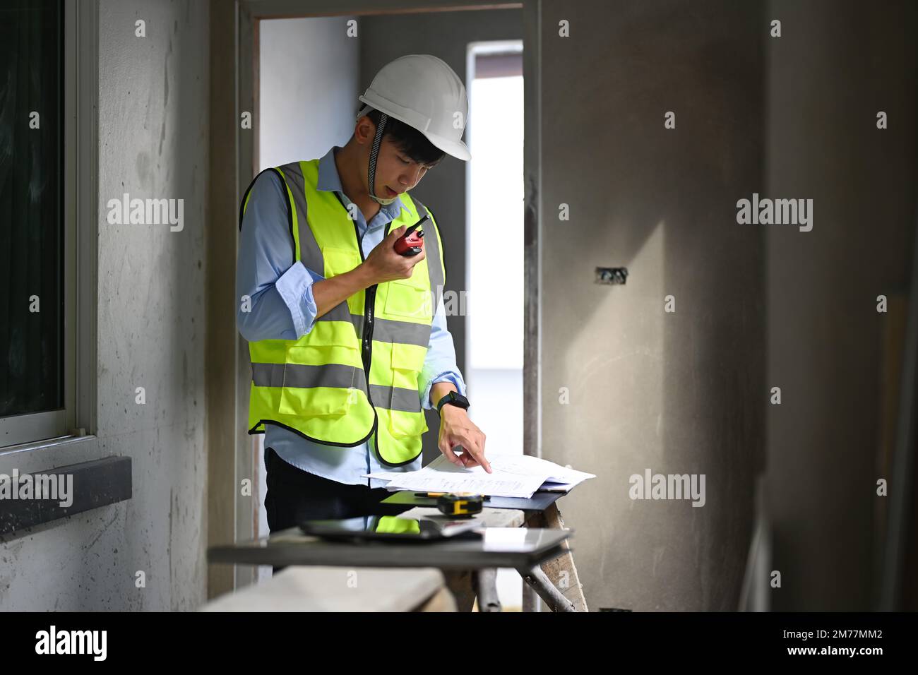 Civil engineer using walkie talkie to communication with co worker team ...