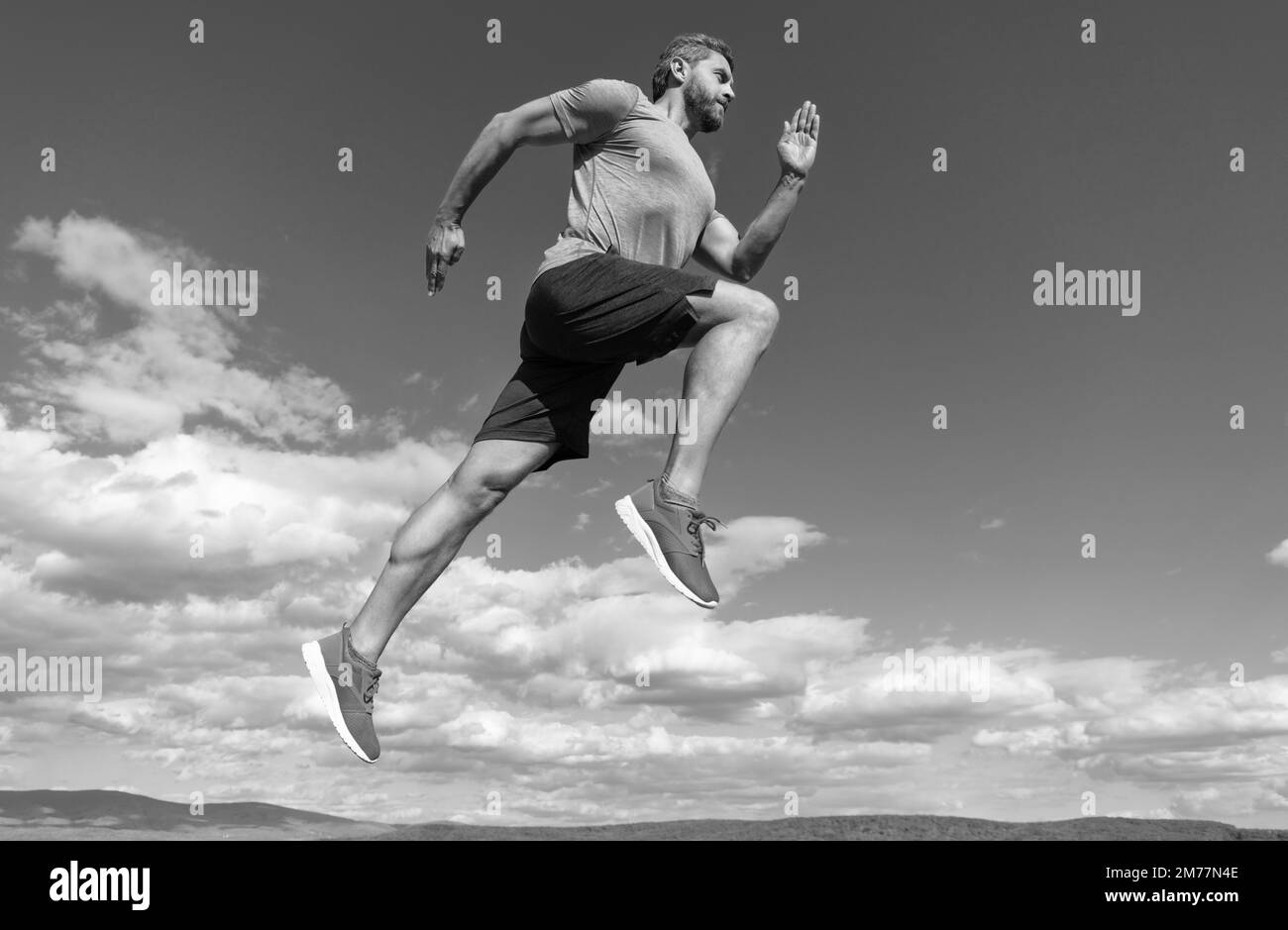 muscular man running in sportswear outdoor on sky background, challenge ...