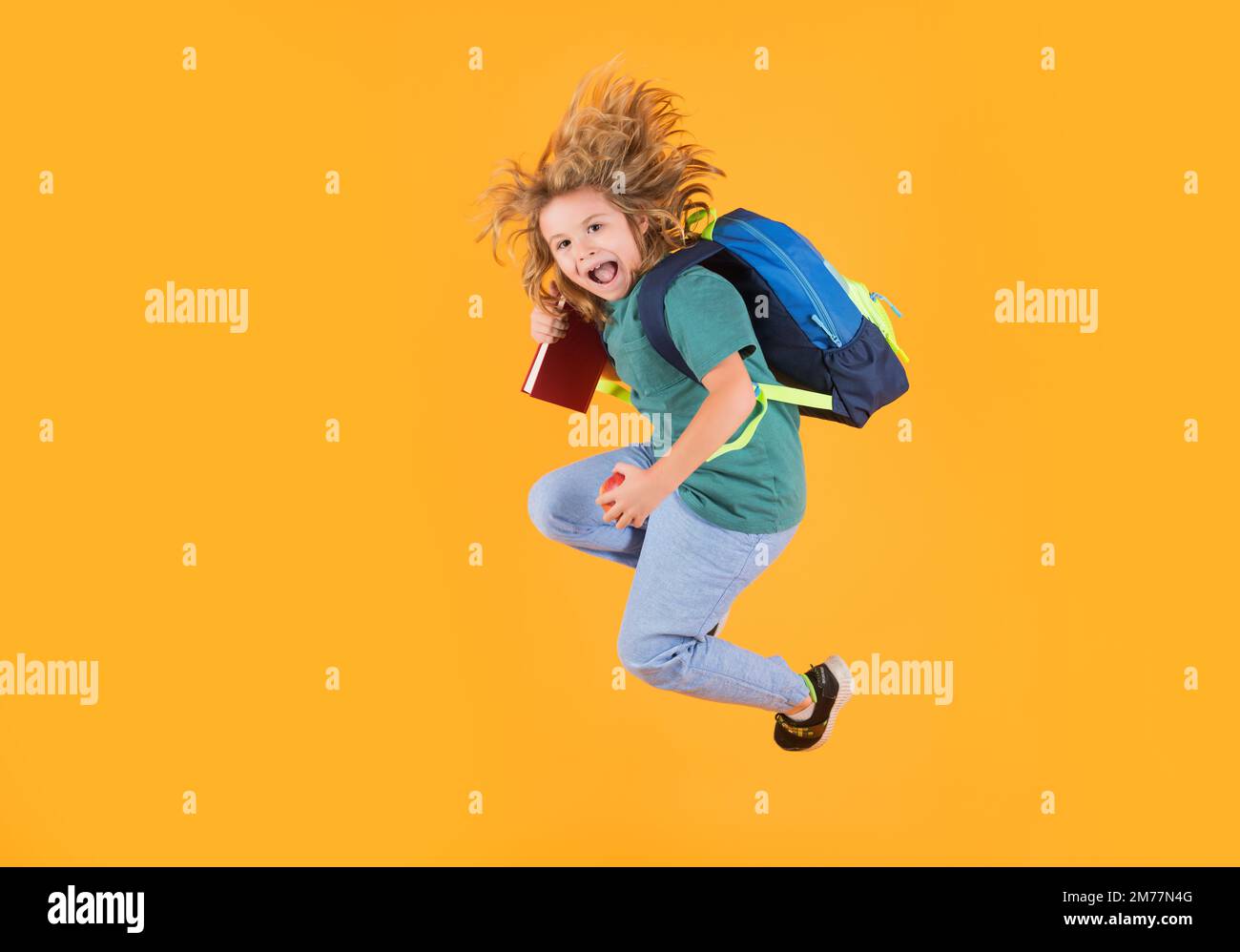 Full length of excited kid jumping. Back to school. Full length body of ...