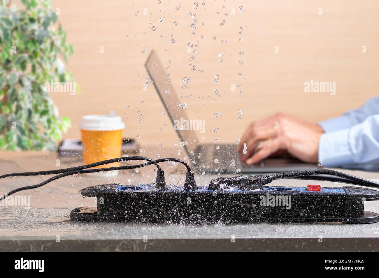 Close up of a bank of plugs on a desk with water leaks falling next to ...
