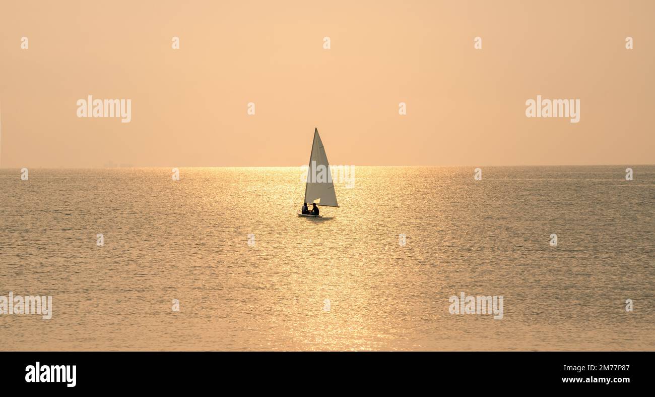 Windsurfing at sunset beatiful golden Sea horizon view. Golden Sea at ...