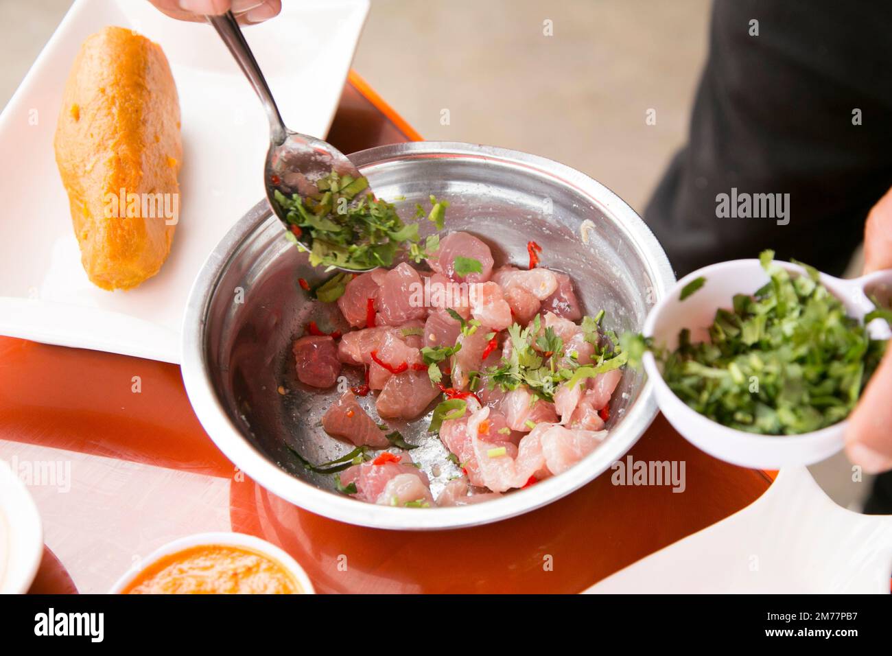 Preparing a delicious Peruvian sea bass ceviche in the fishing port of ...