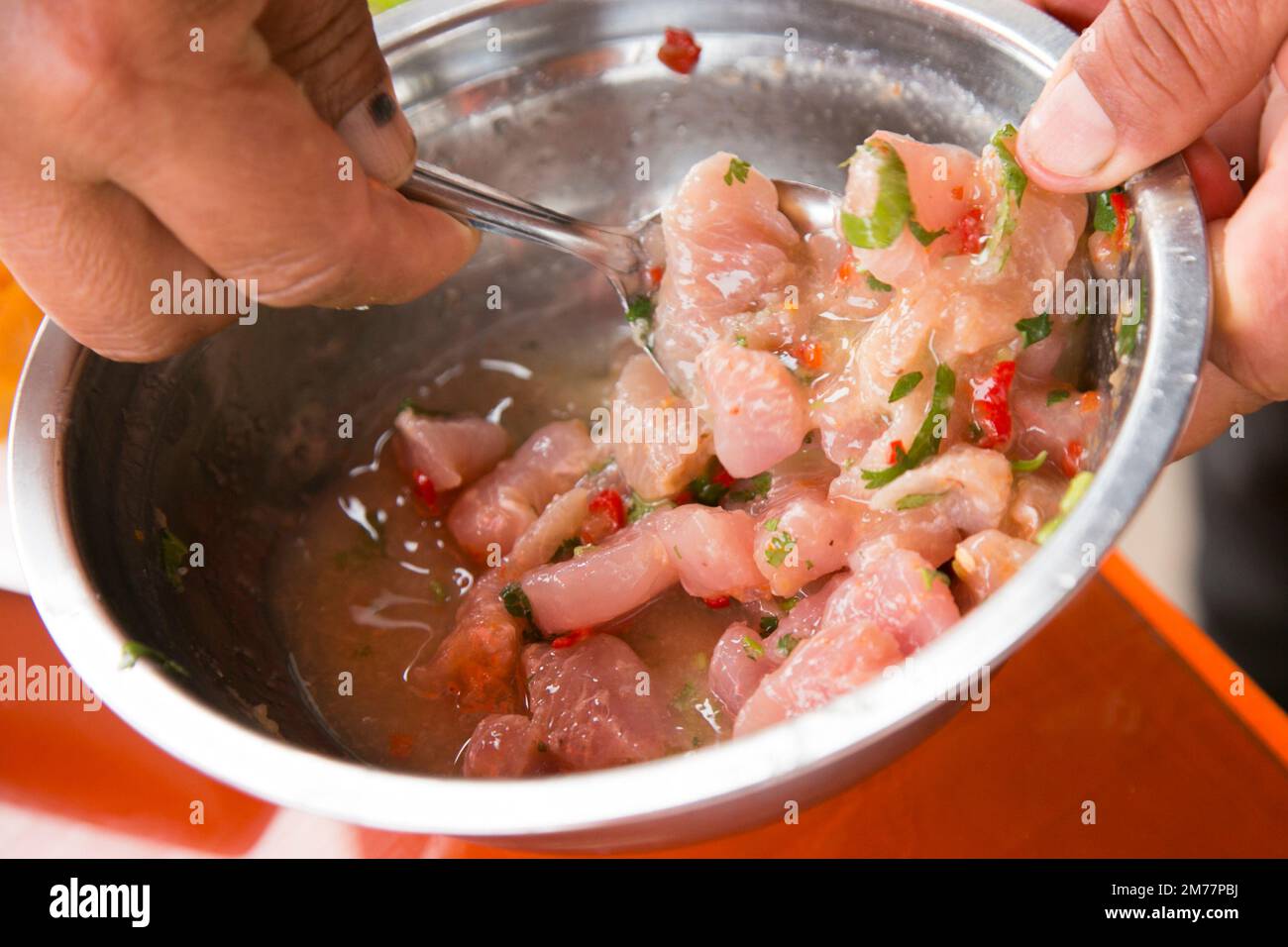 Preparing a delicious Peruvian sea bass ceviche in the fishing port of ...