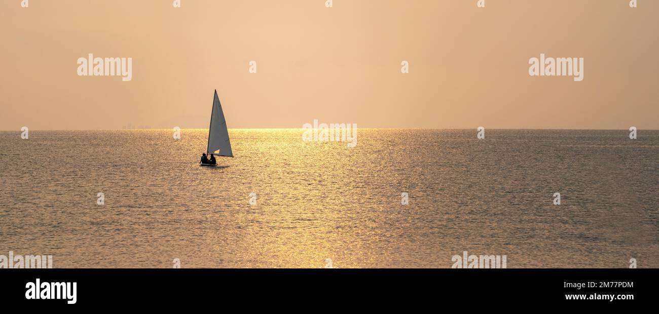 Windsurfing at sunset beatiful golden Sea horizon view. Golden Sea at ...