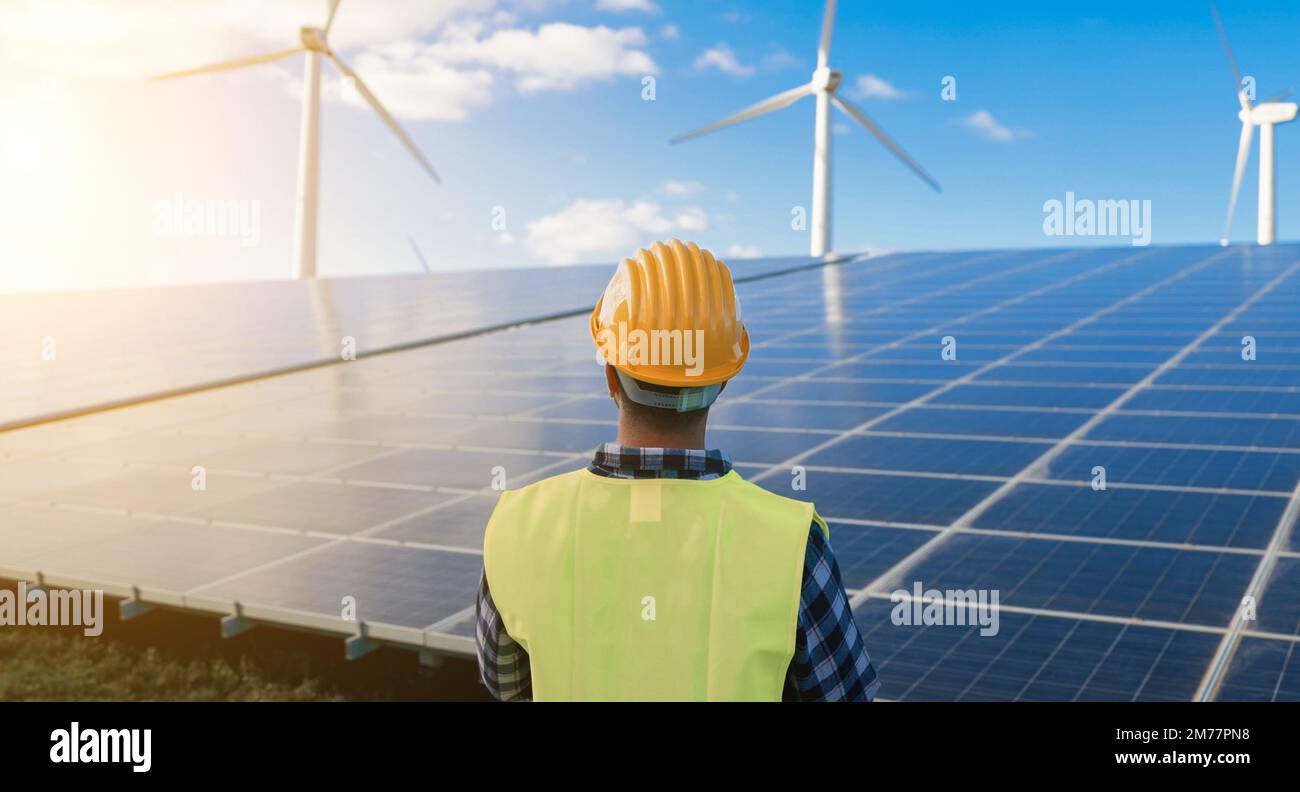 Engineer working for alternative energy farm - Wind turbine and solar ...
