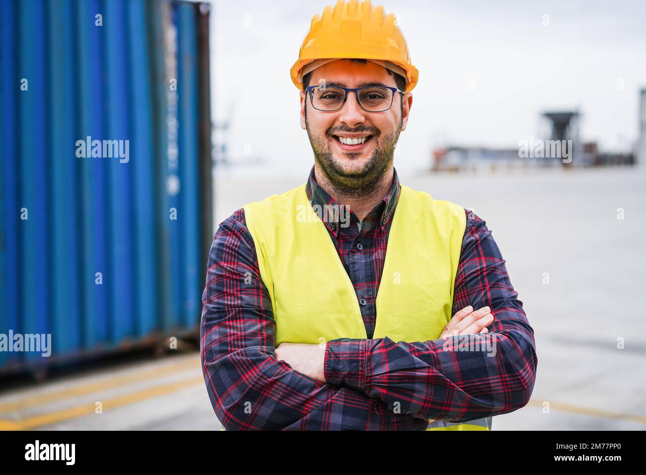 Young man working with shipping containers at industrial port outdoor ...