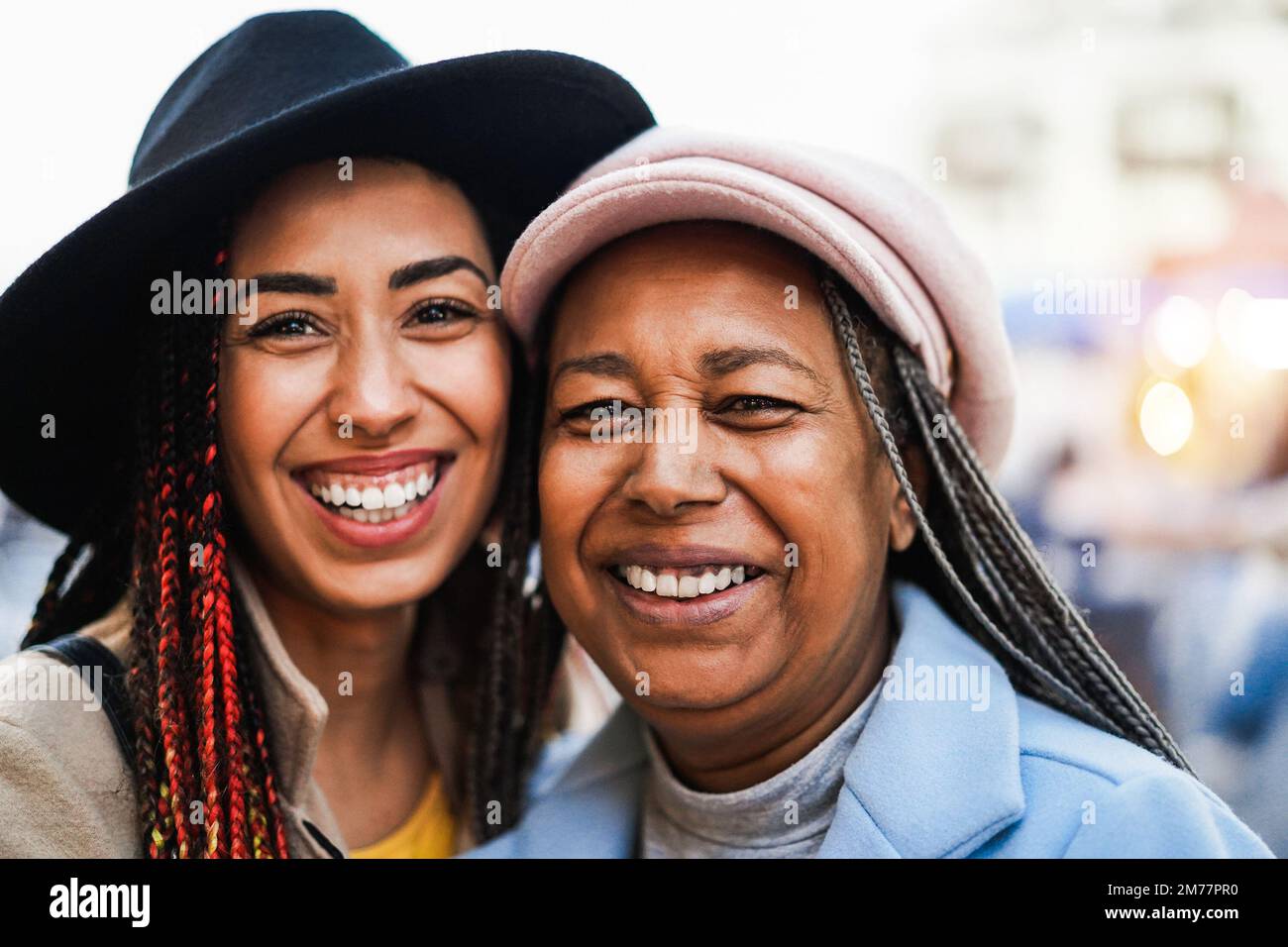 African mother and daughter having fun together during winter time ...