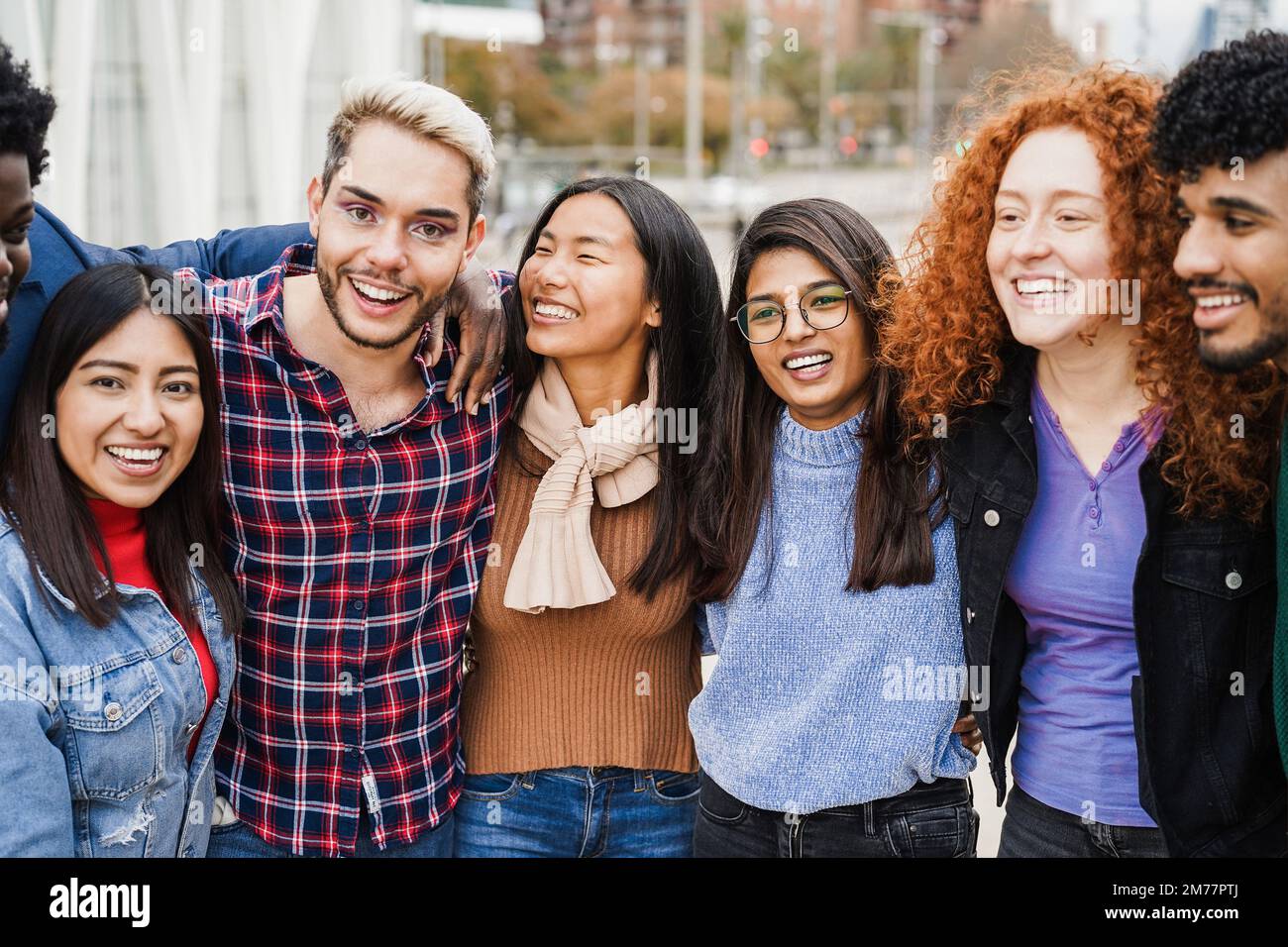 Young diverse people having fun outdoor laughing together - Focus on center asian girl face ...
