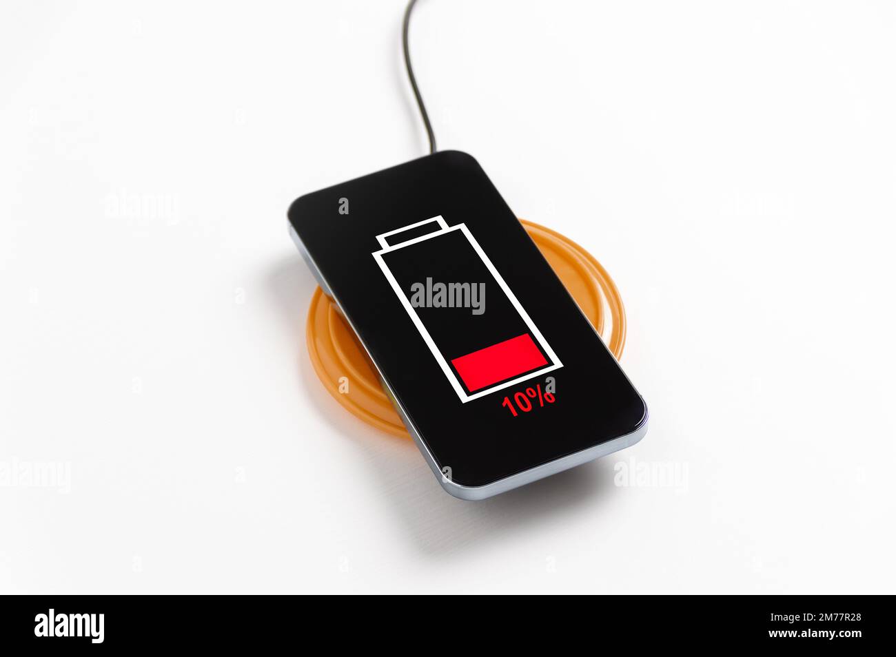 Charging the smartphone with wireless charger with low battery Stock ...