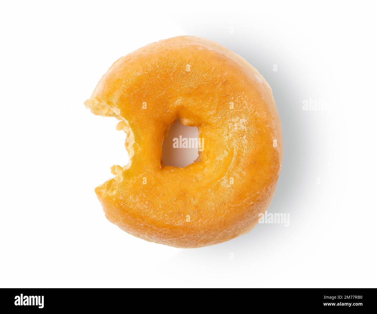 One bite missing of plain donut on white background Stock Photo - Alamy