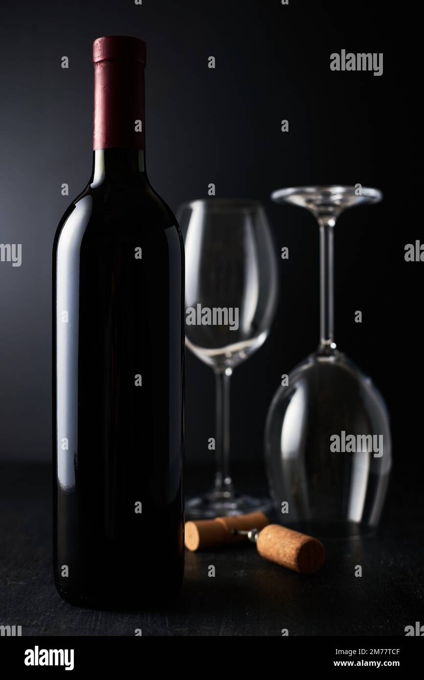 Elegant red wine glass and a wine bottle in black background Stock ...