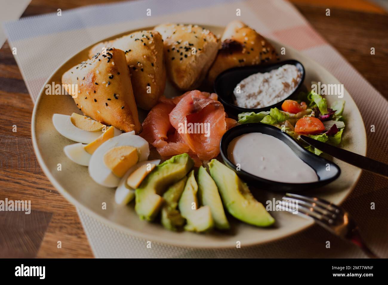 A closeup of a delicious meal in a round plate with meat pie, eggs and ...