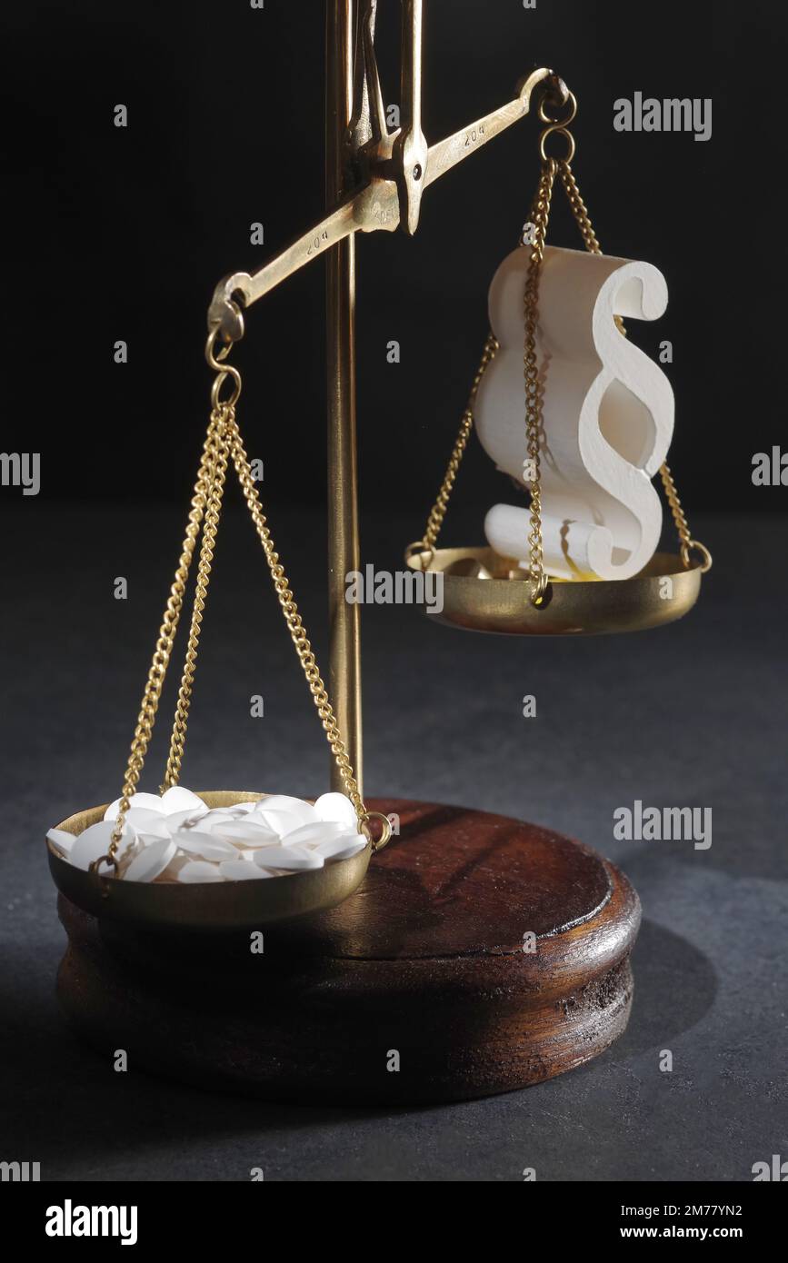 Law in medicine. Scales justice and pills on an abstract background ...