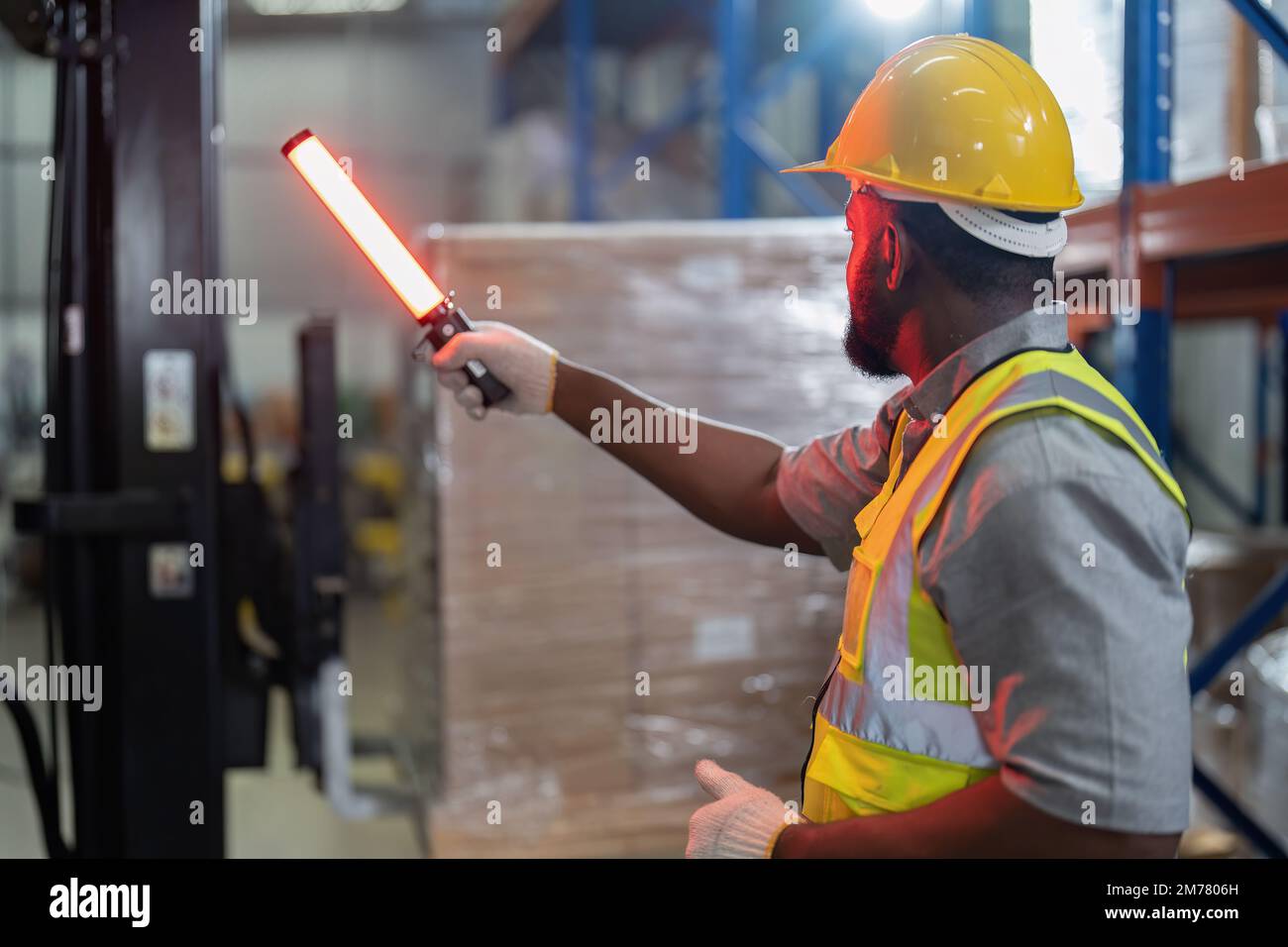 African american working in warehouse hold red light give signal to ...