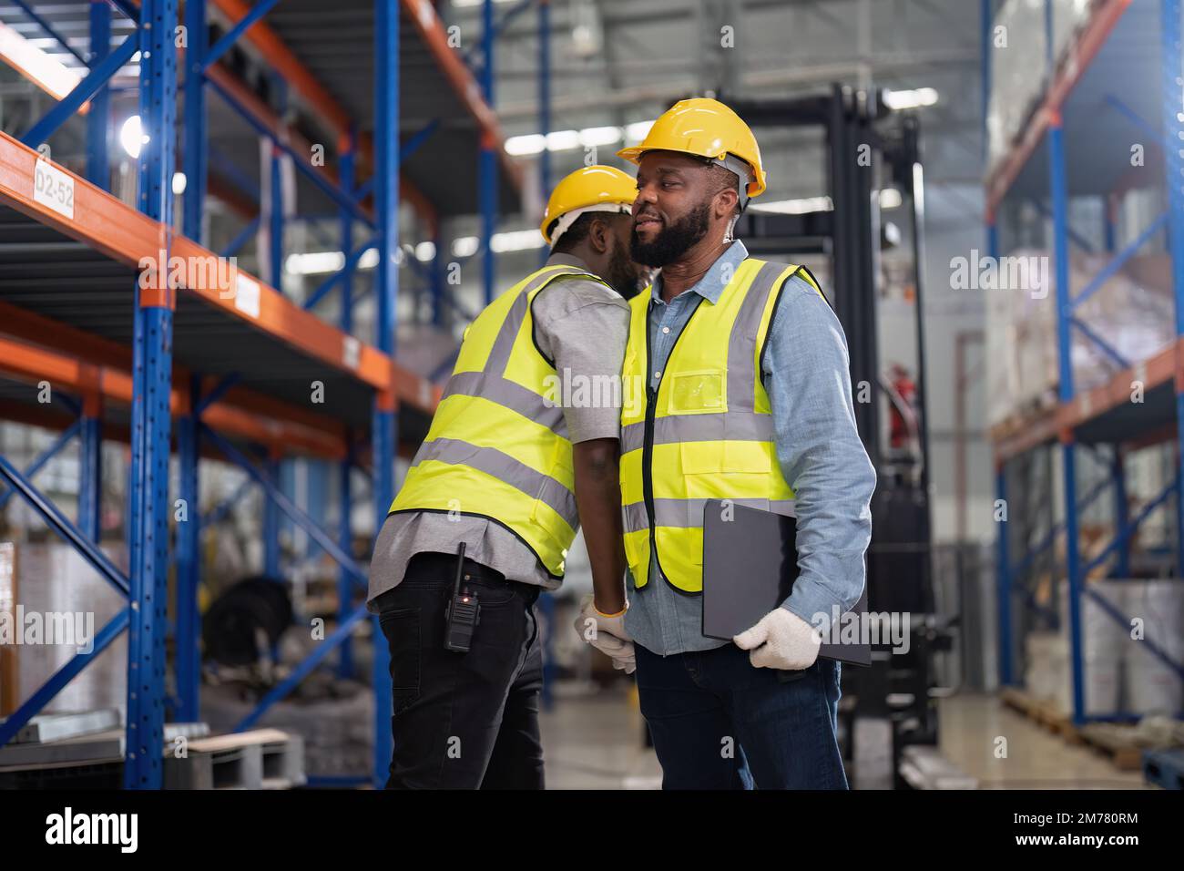 African american working in warehouse check forklift truck loading ...