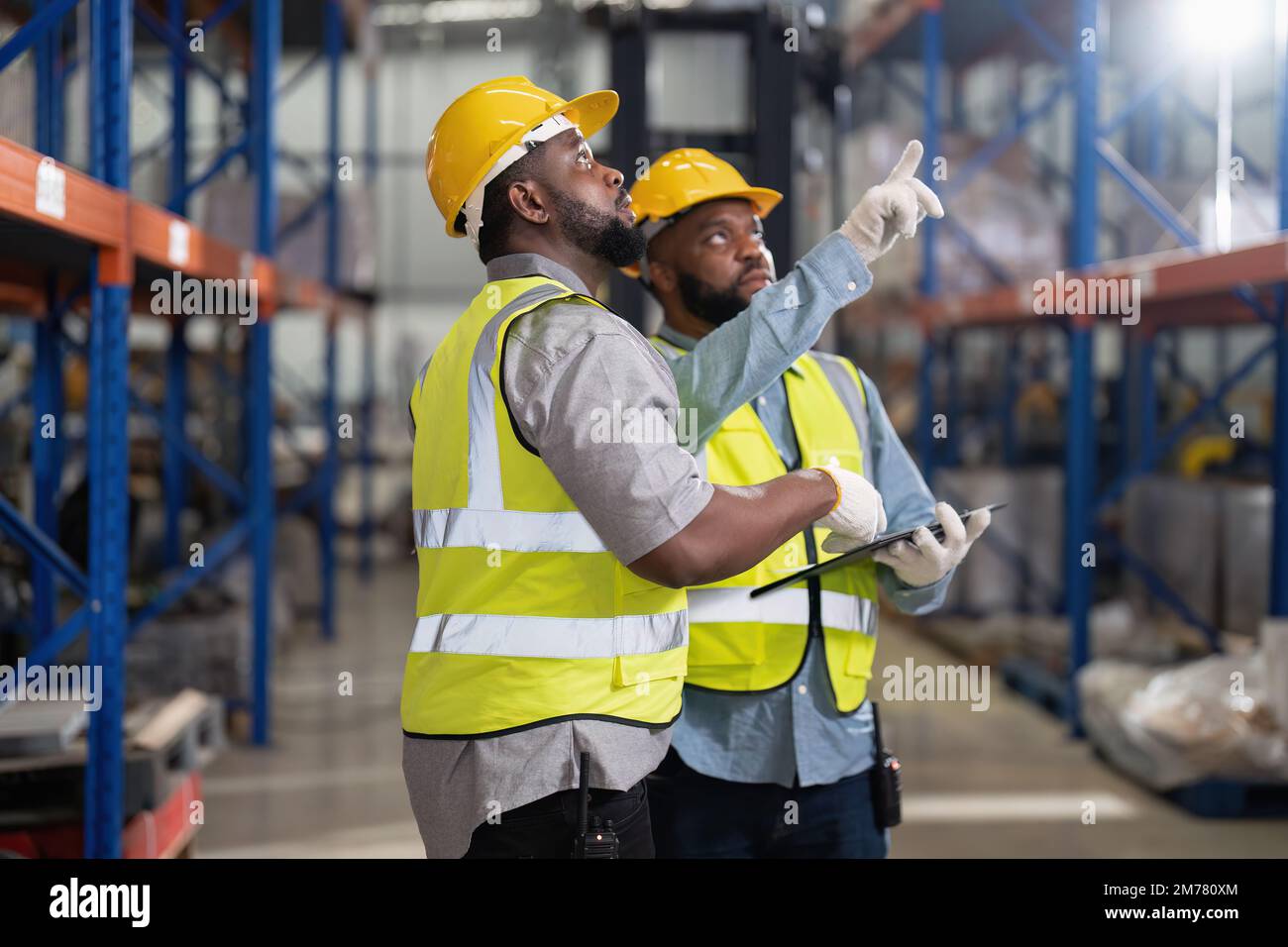 African american working in warehouse check forklift truck loading ...