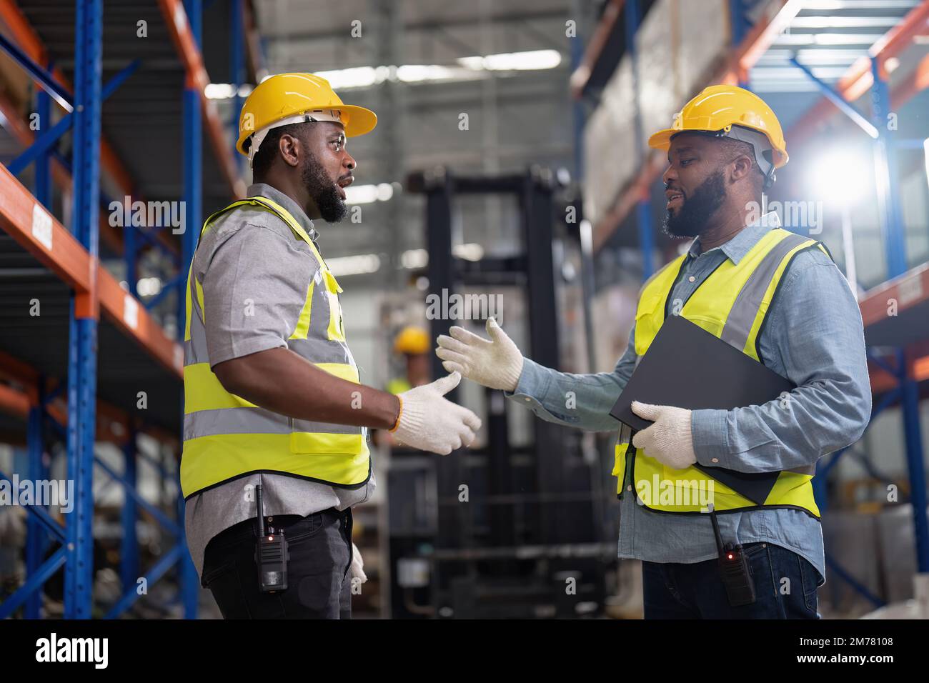 African american working in warehouse check forklift truck loading ...