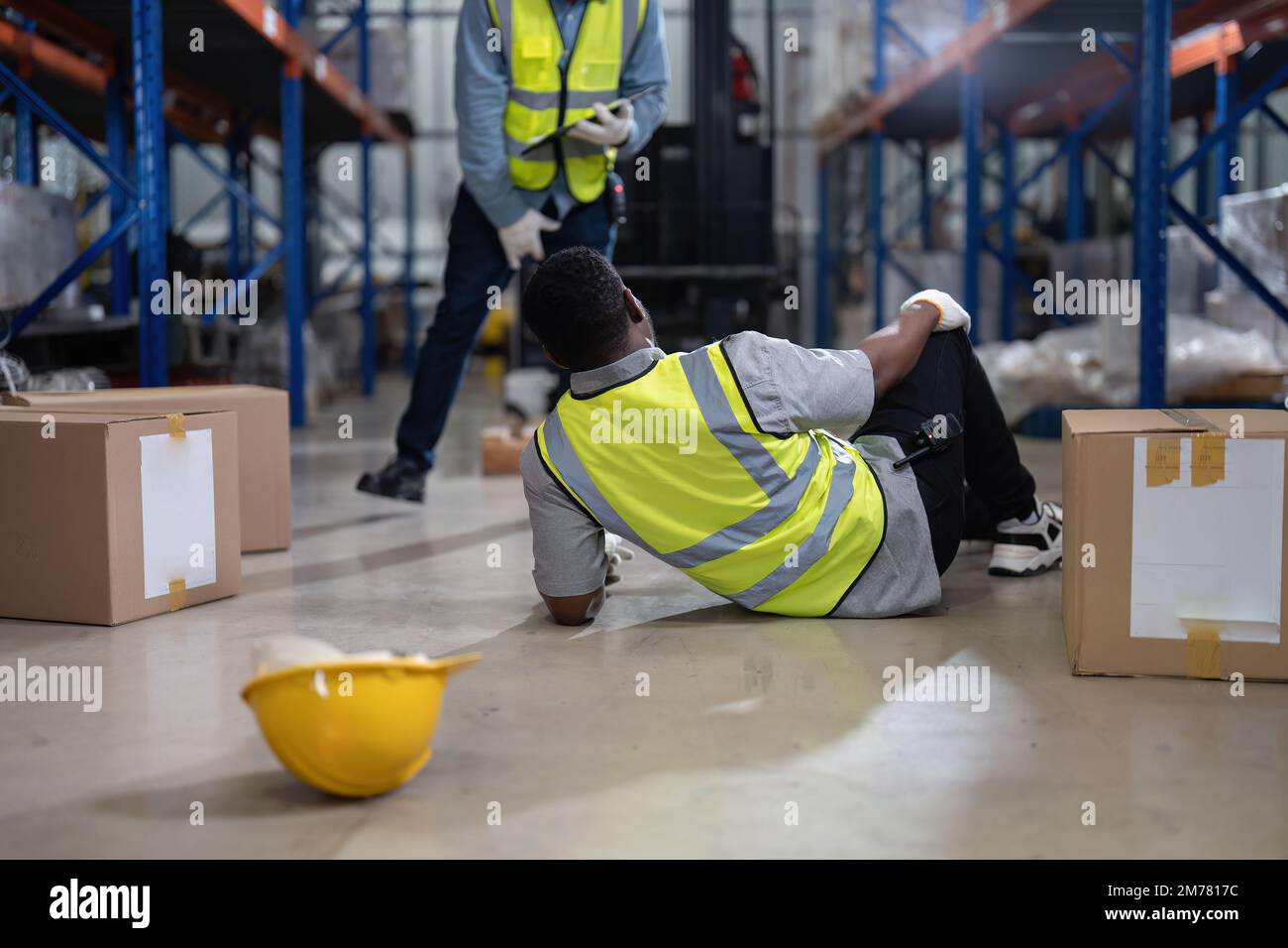 African american working in warehouse got accident from carry box ...