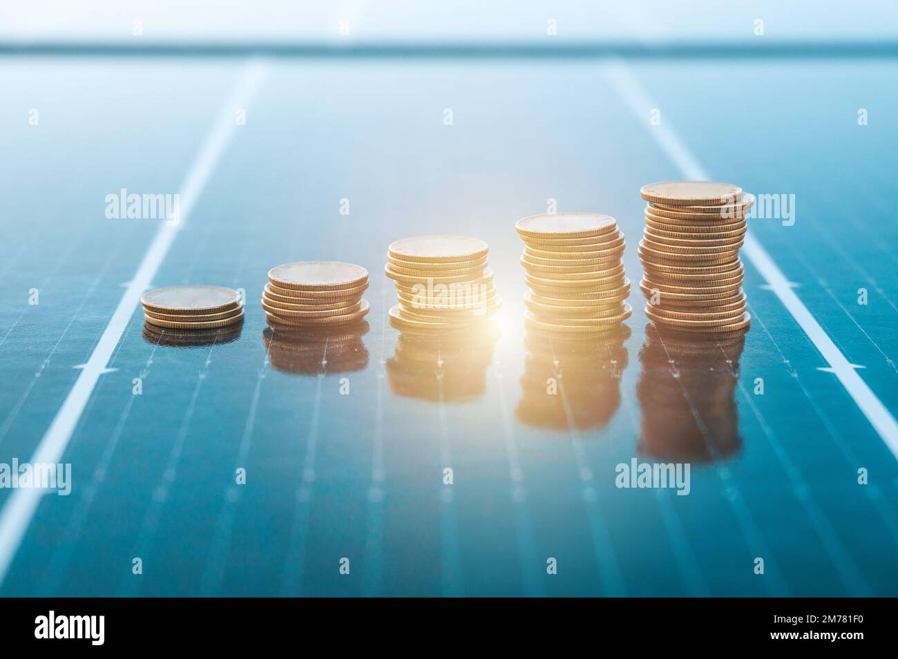 Money saved by using energy with solar panel Stock Photo - Alamy