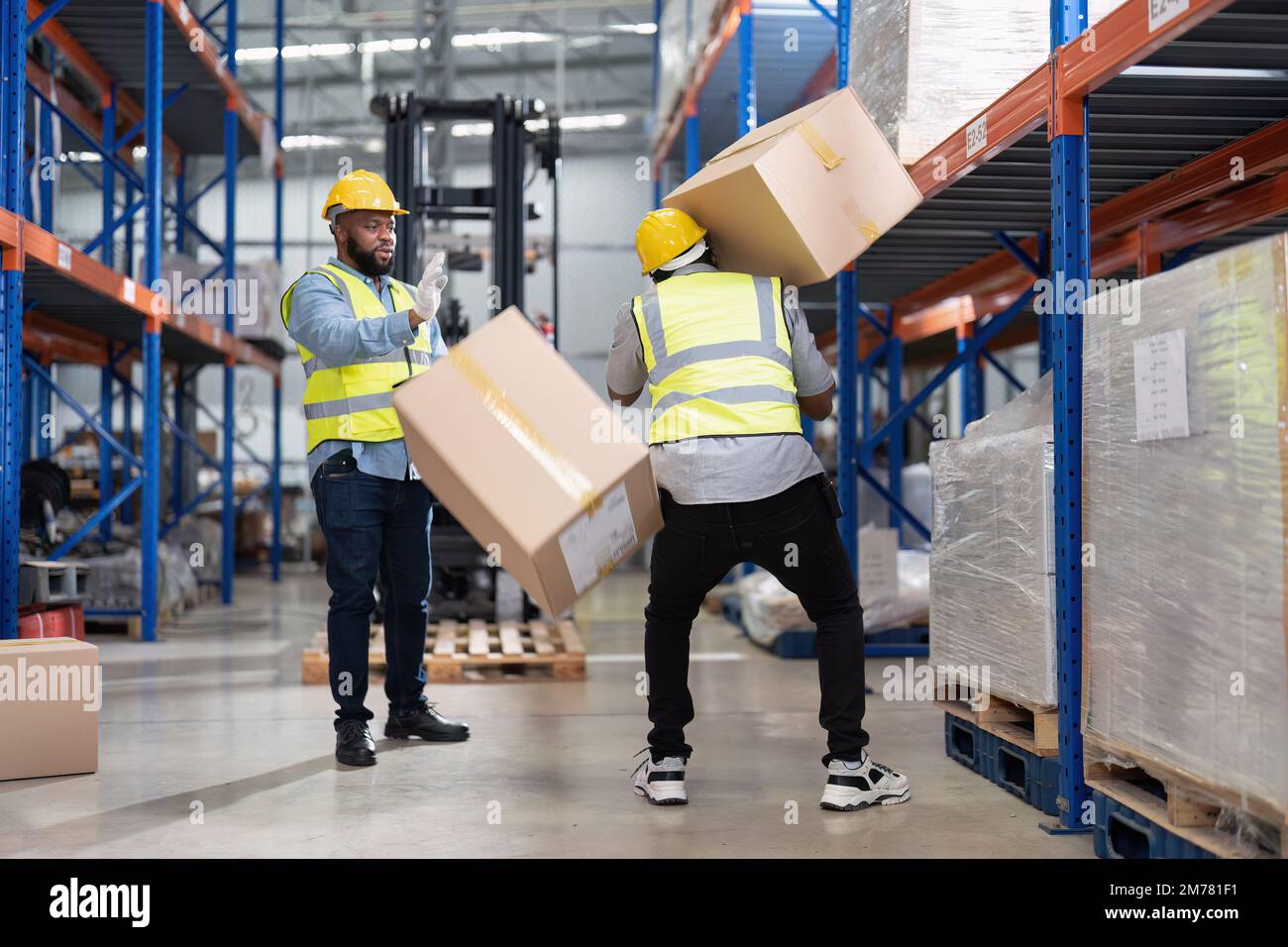 African american working in warehouse got accident from carry box ...