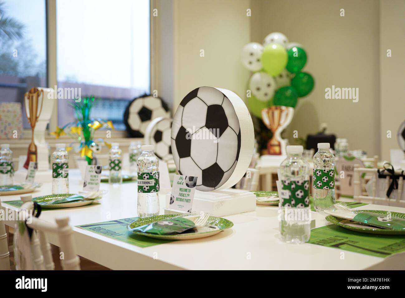 Kids' soccer or football-themed party table with plastic cutlery and ...