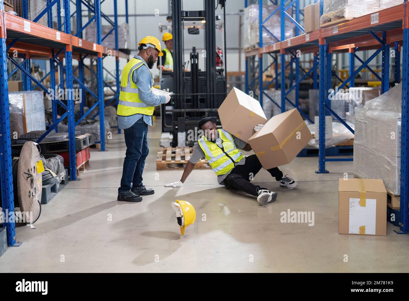 African american working in warehouse got accident from carry box ...