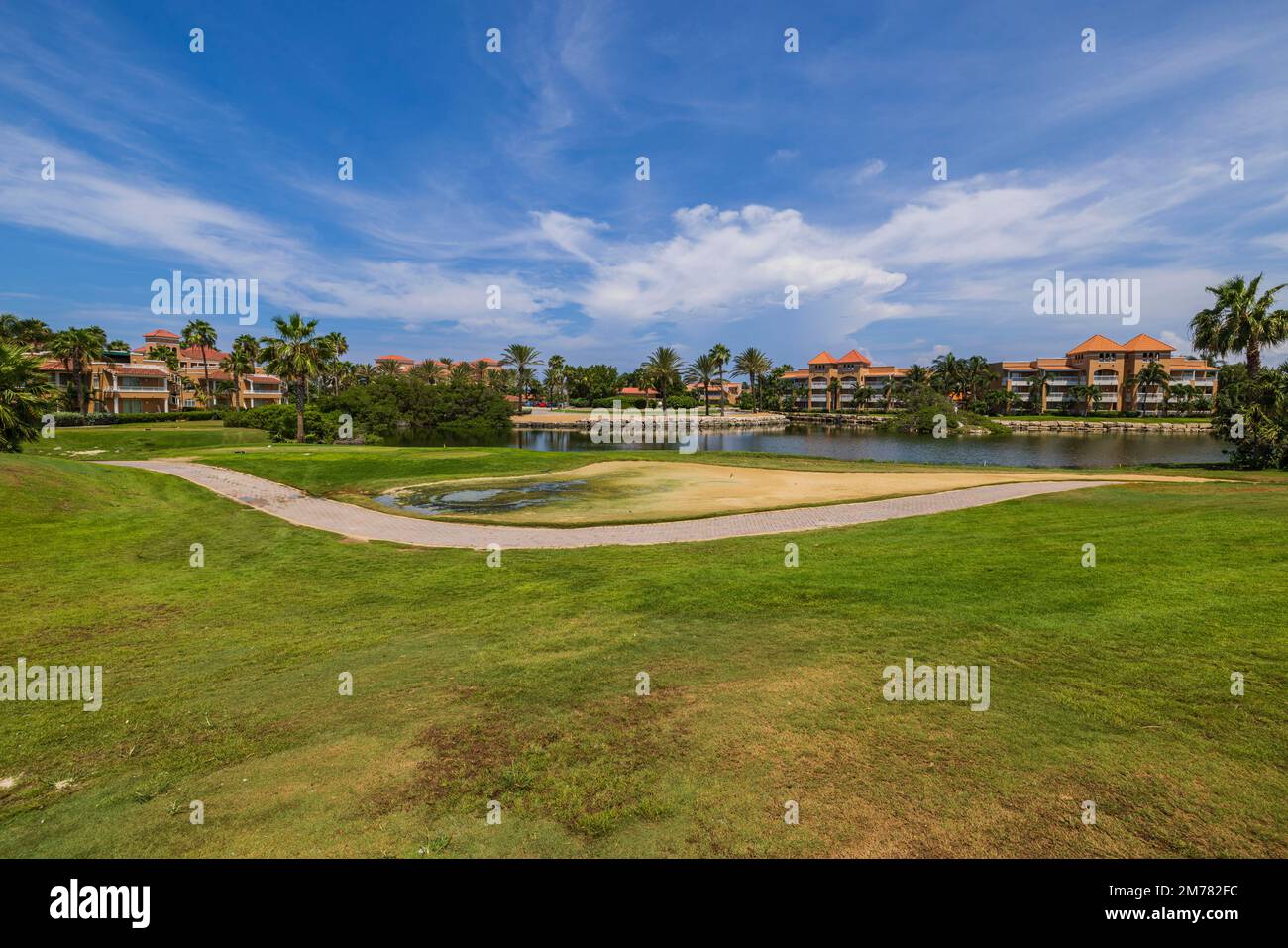 Beautiful panoramic view of hotel grounds with golf course on blue sky ...