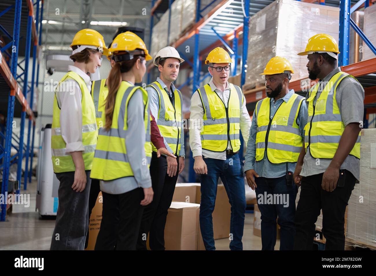 Diversity group of worker in warehouse stand round hand gathering boost ...