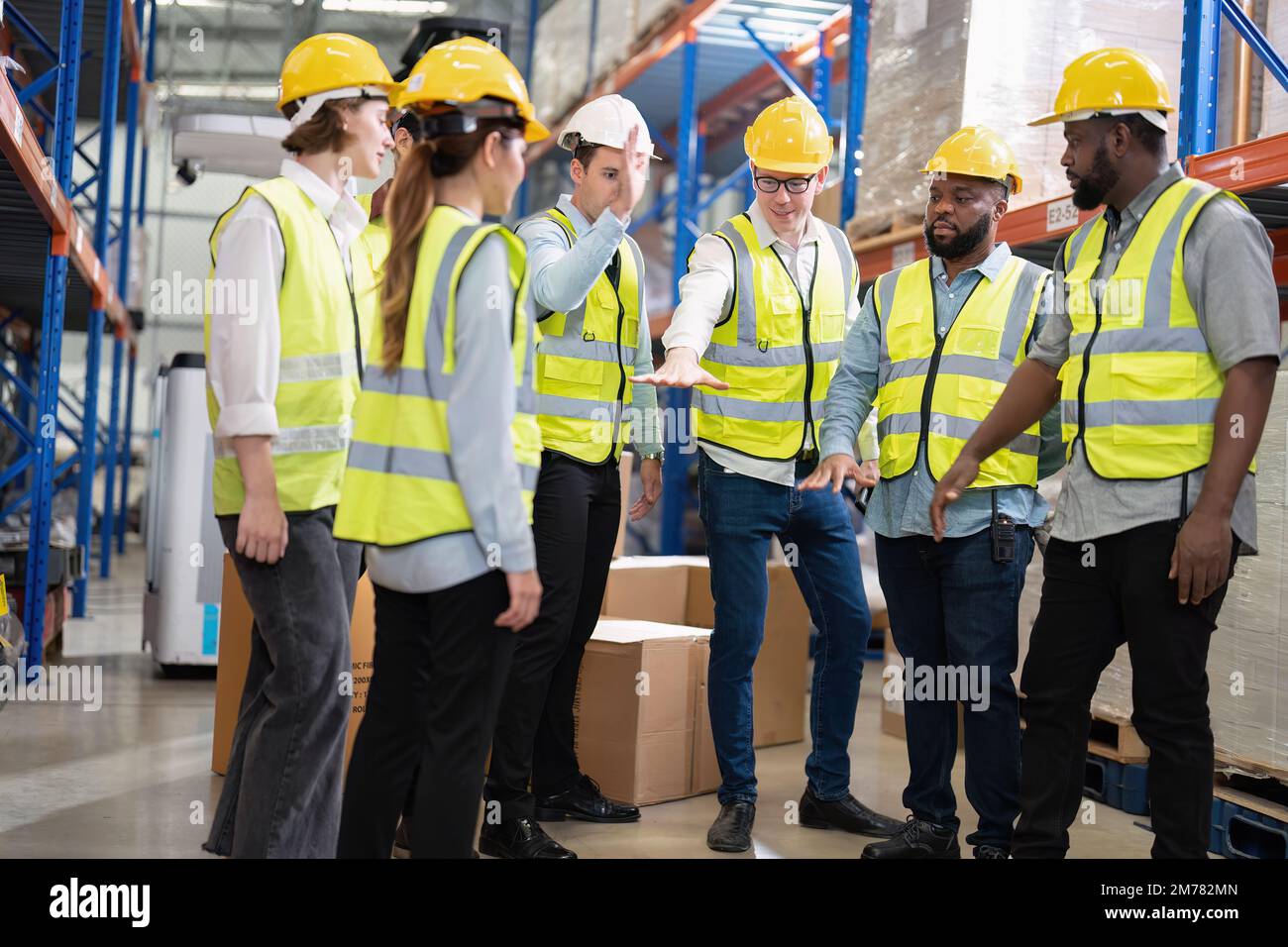 Diversity group of worker in warehouse stand round hand gathering boost ...