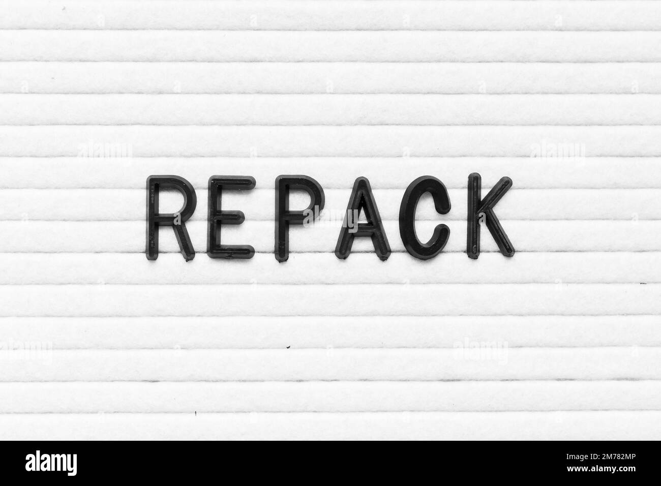 Black color letter in word repack on white felt board background Stock ...