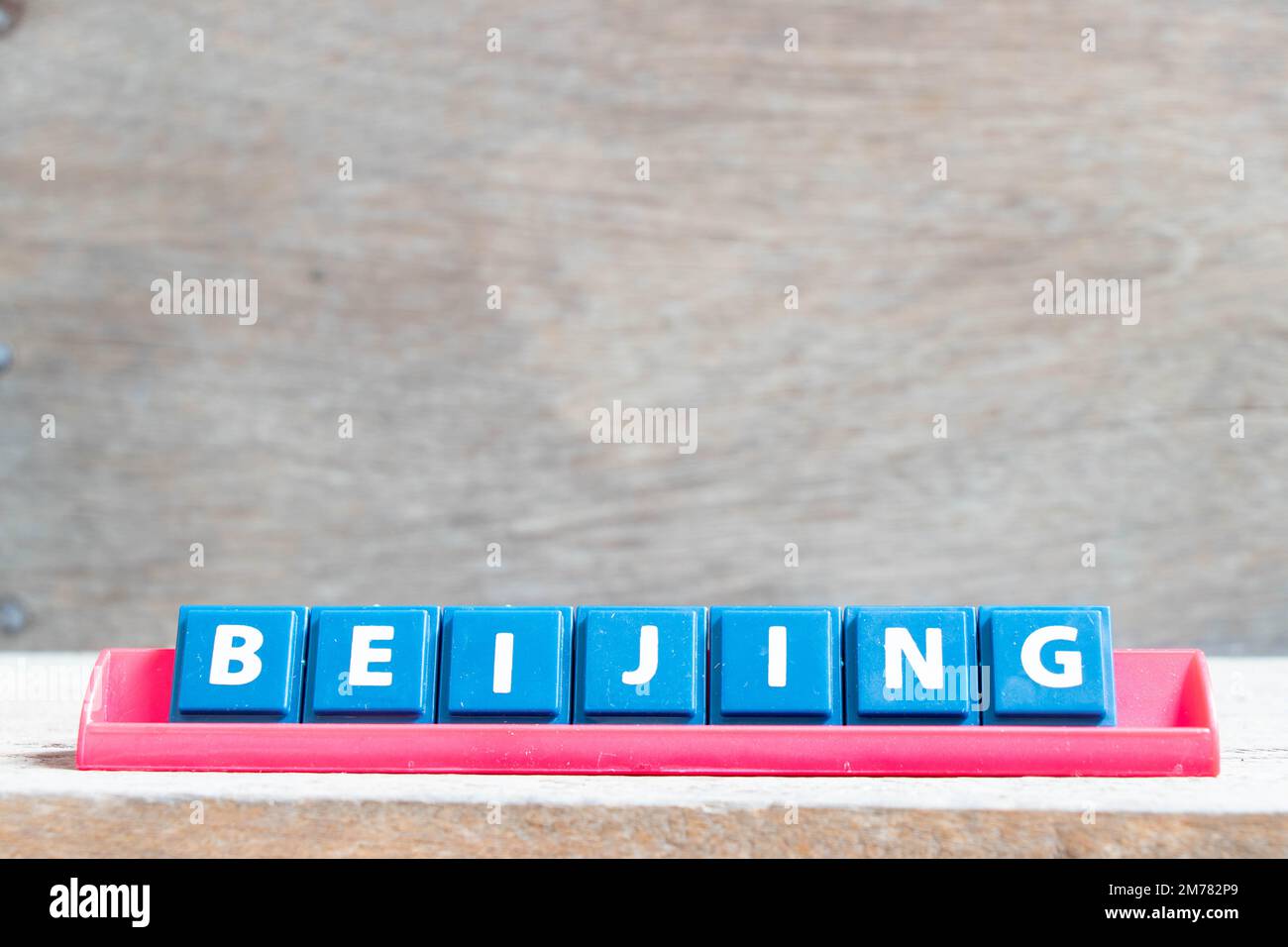 Tile alphabet letter with word beijing in red color rack on wood ...