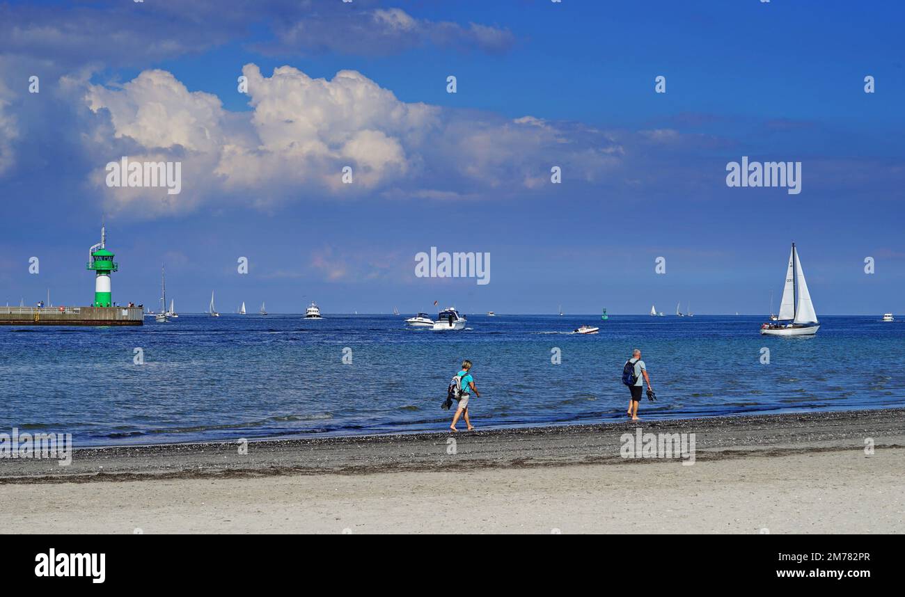 A beautiful view of people walking on the shore of Travemunde Strand ...