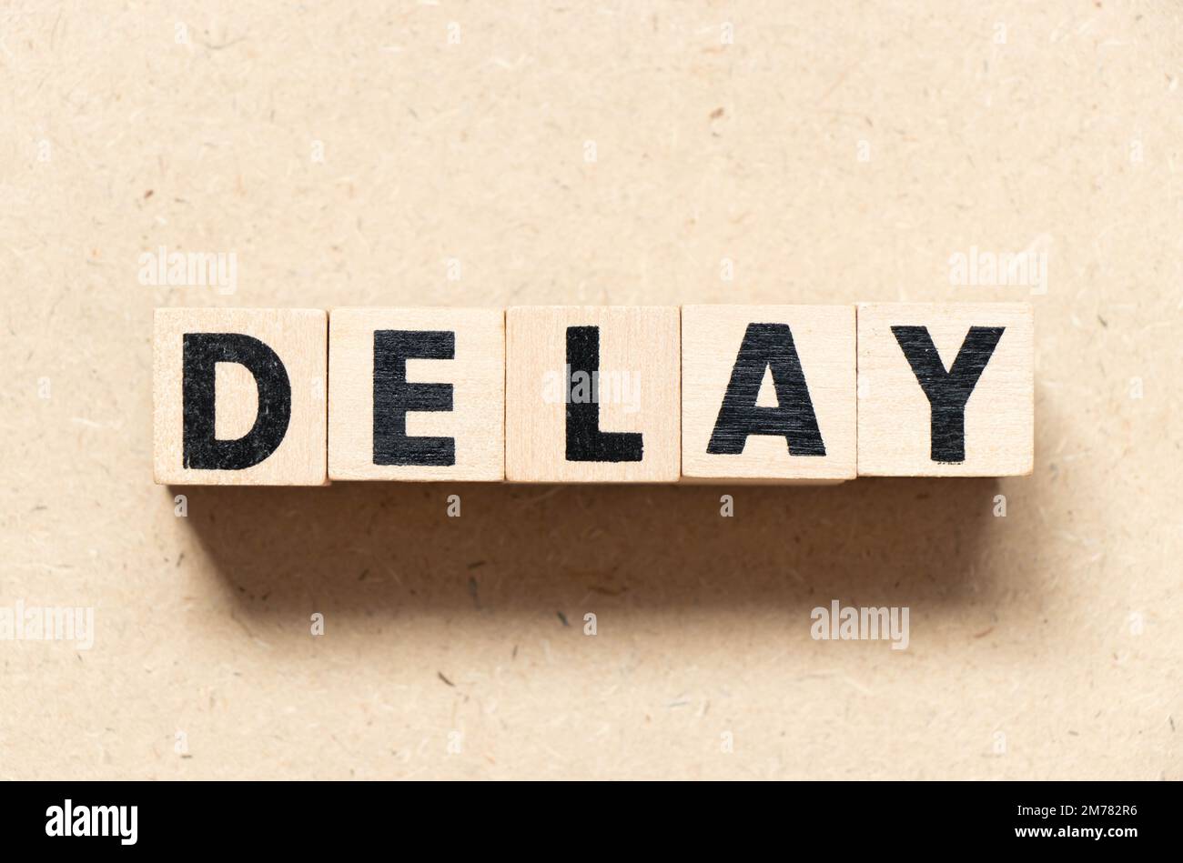 Alphabet letter block in word delay on wood background Stock Photo - Alamy