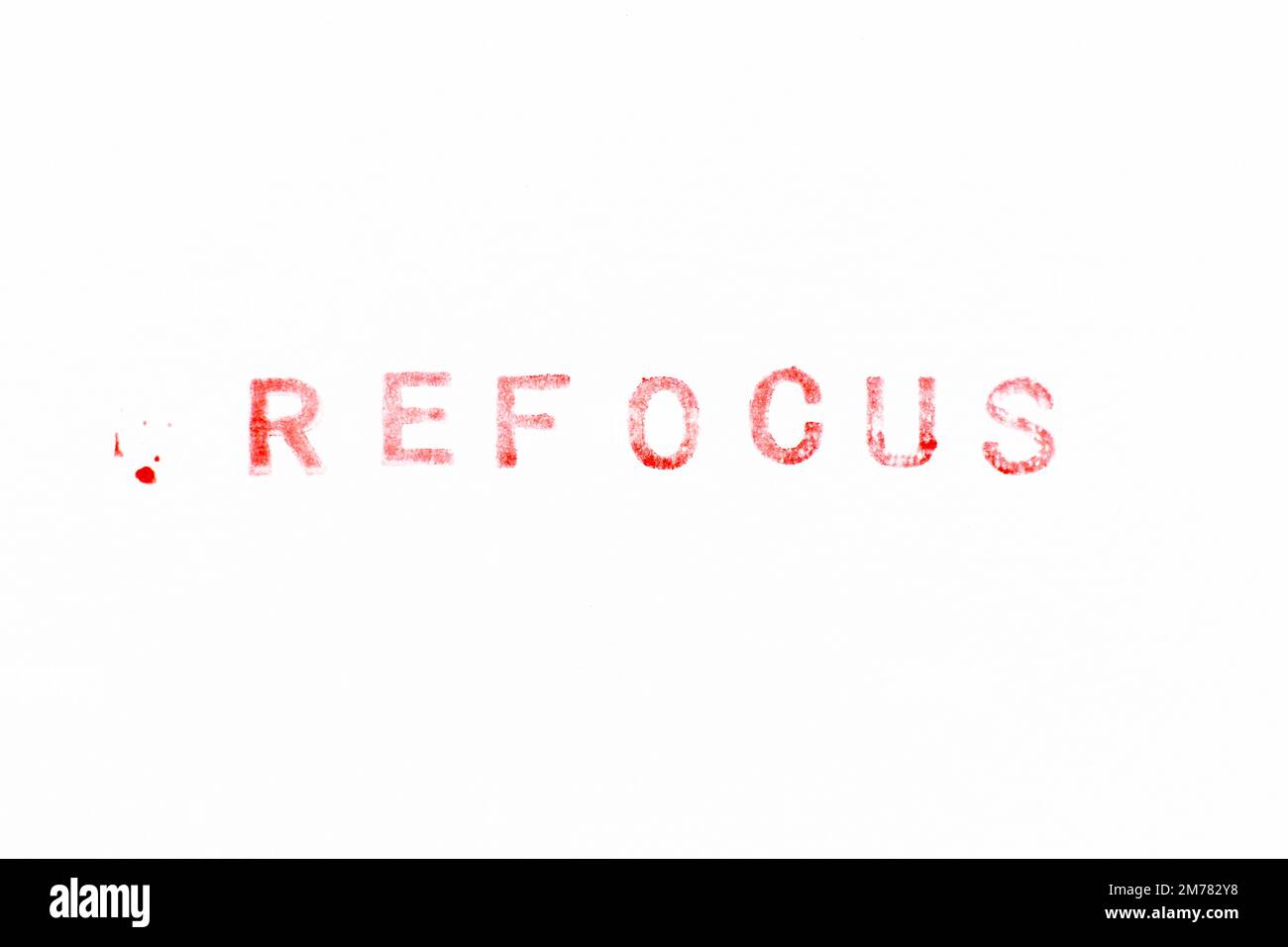 Red color ink rubber stamp in word refocus on white paper background ...