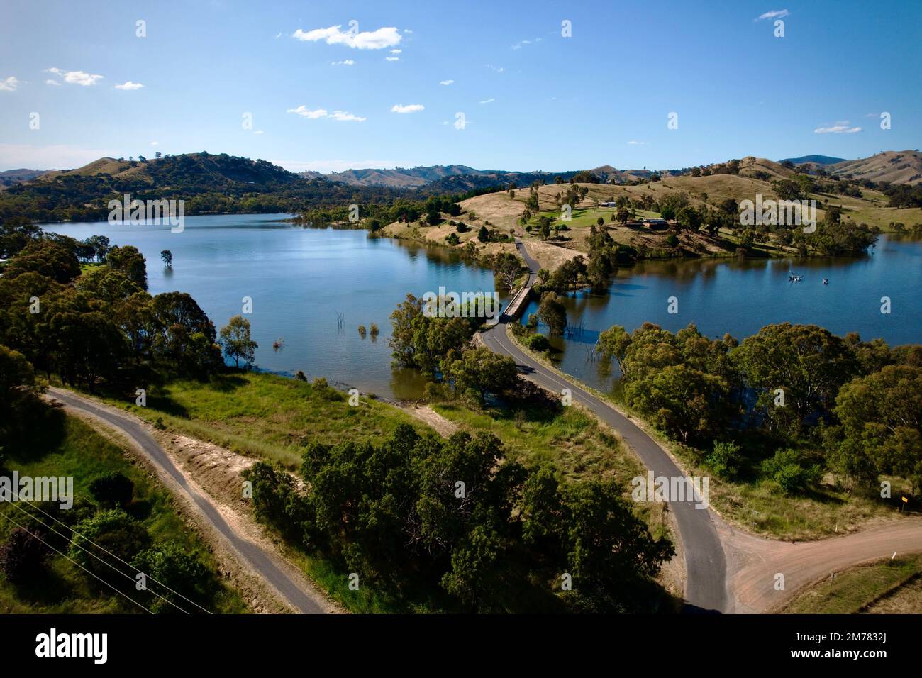 A bird's eye view of a bridge on Lake Eildon surrounded by mountains in ...