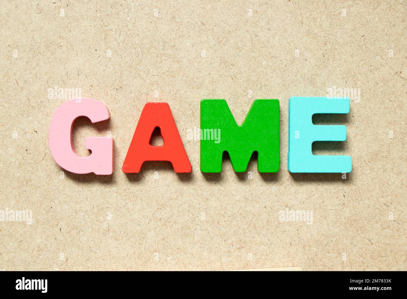 Color alphabet letter in word game on wood background Stock Photo - Alamy