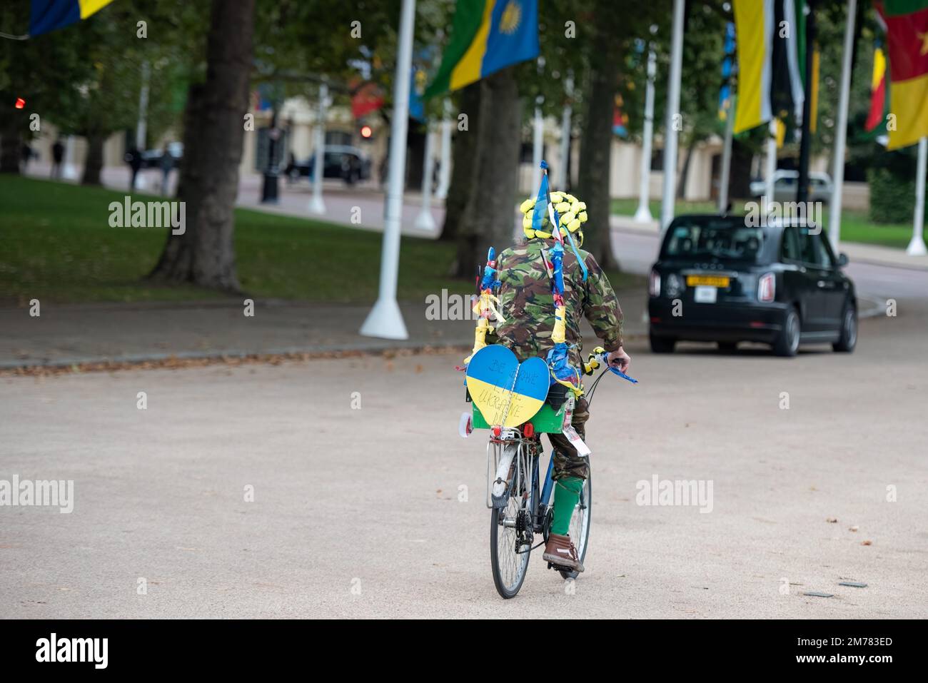A scene of a person in military clothing riding a bicycle with a ...