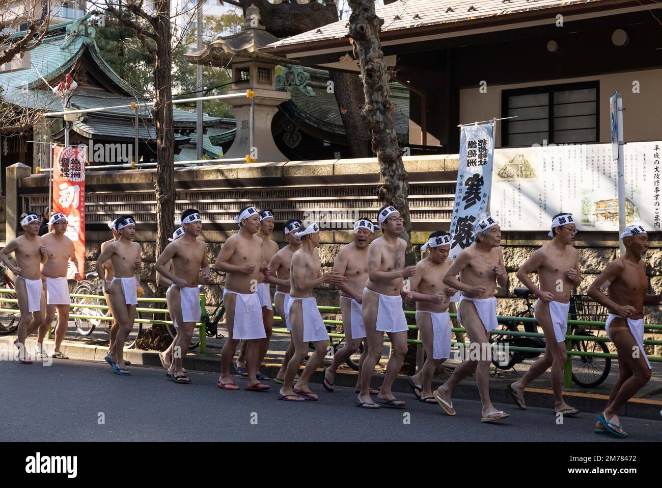 Participants of the 68th Teppozu Inari Shrine Kanchu Suiyoku event are ...