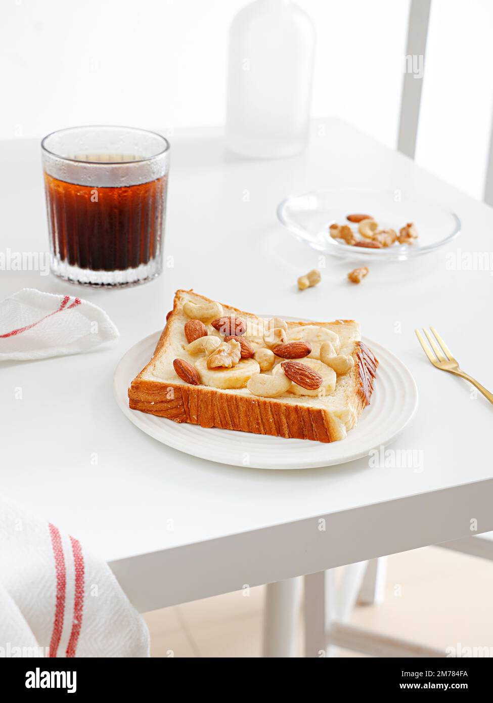 A top view of a Peanut Butter Banana Toast on white table Stock Photo ...