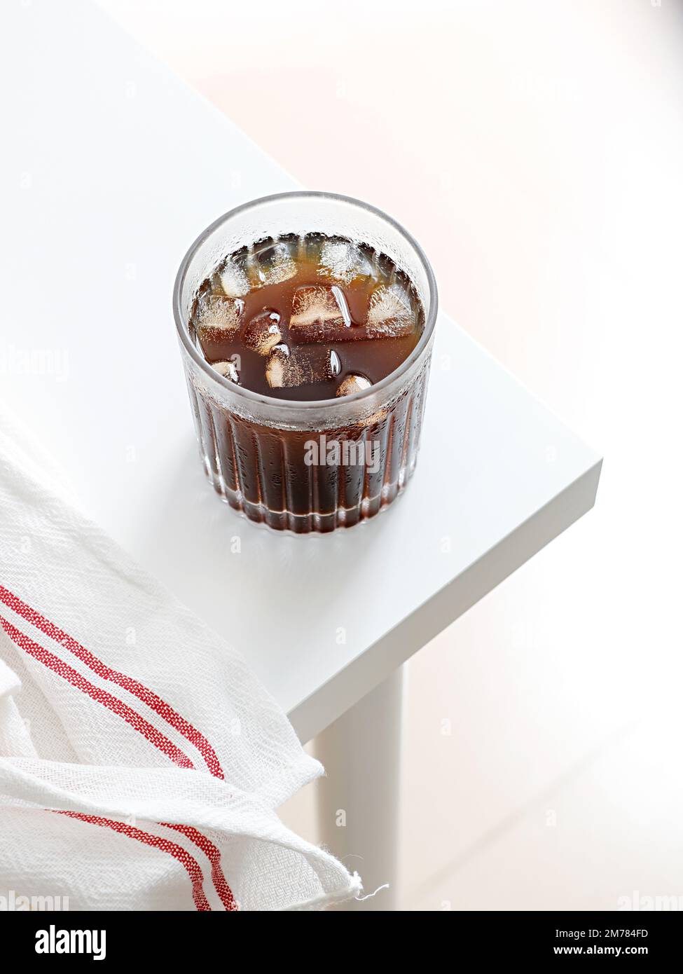 A top view of a glass of iced coffee with ice on white background Stock ...