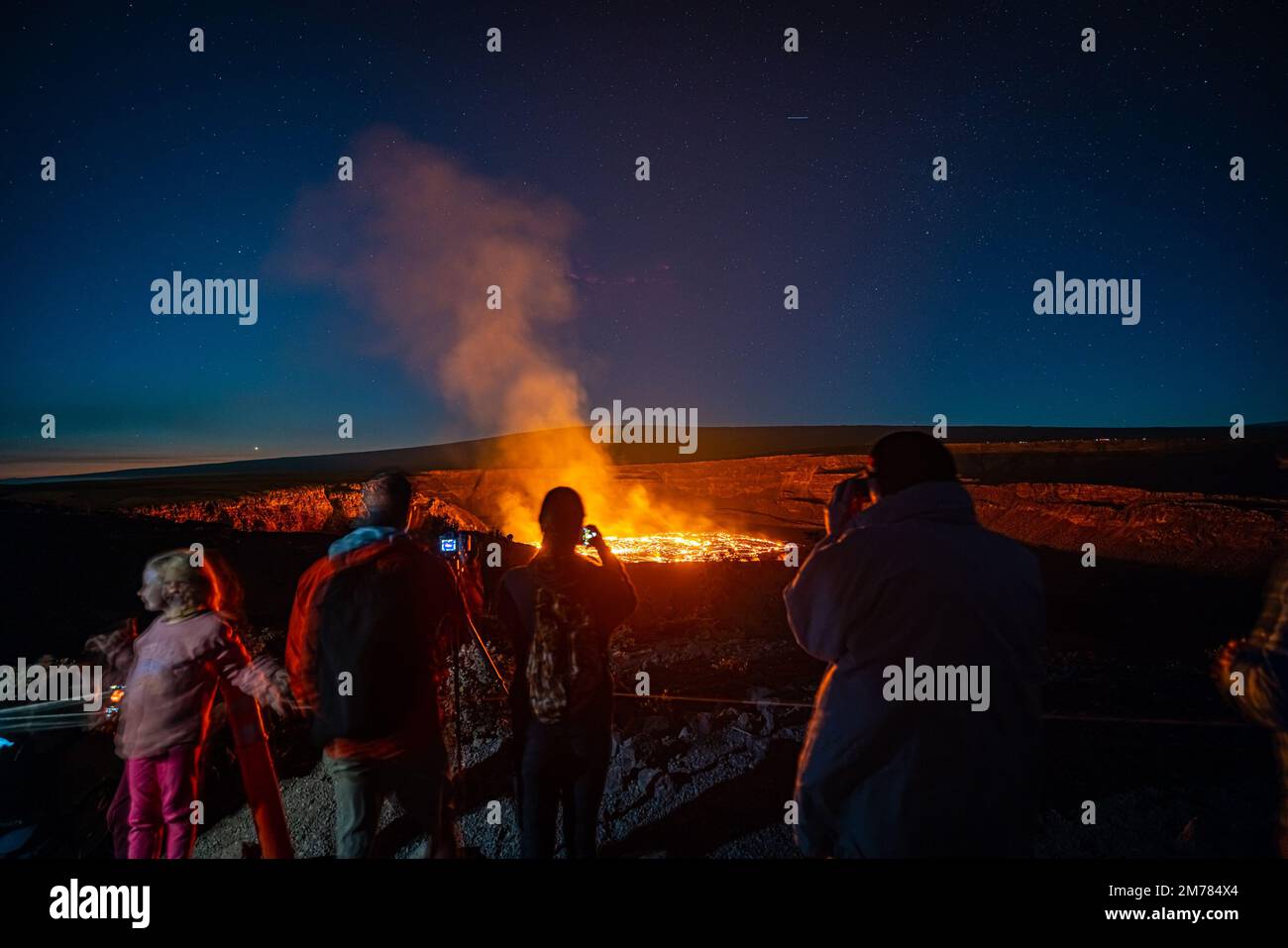 Volcano, HI, USA. 7th Jan, 2023. Spectators observe the eruption ...