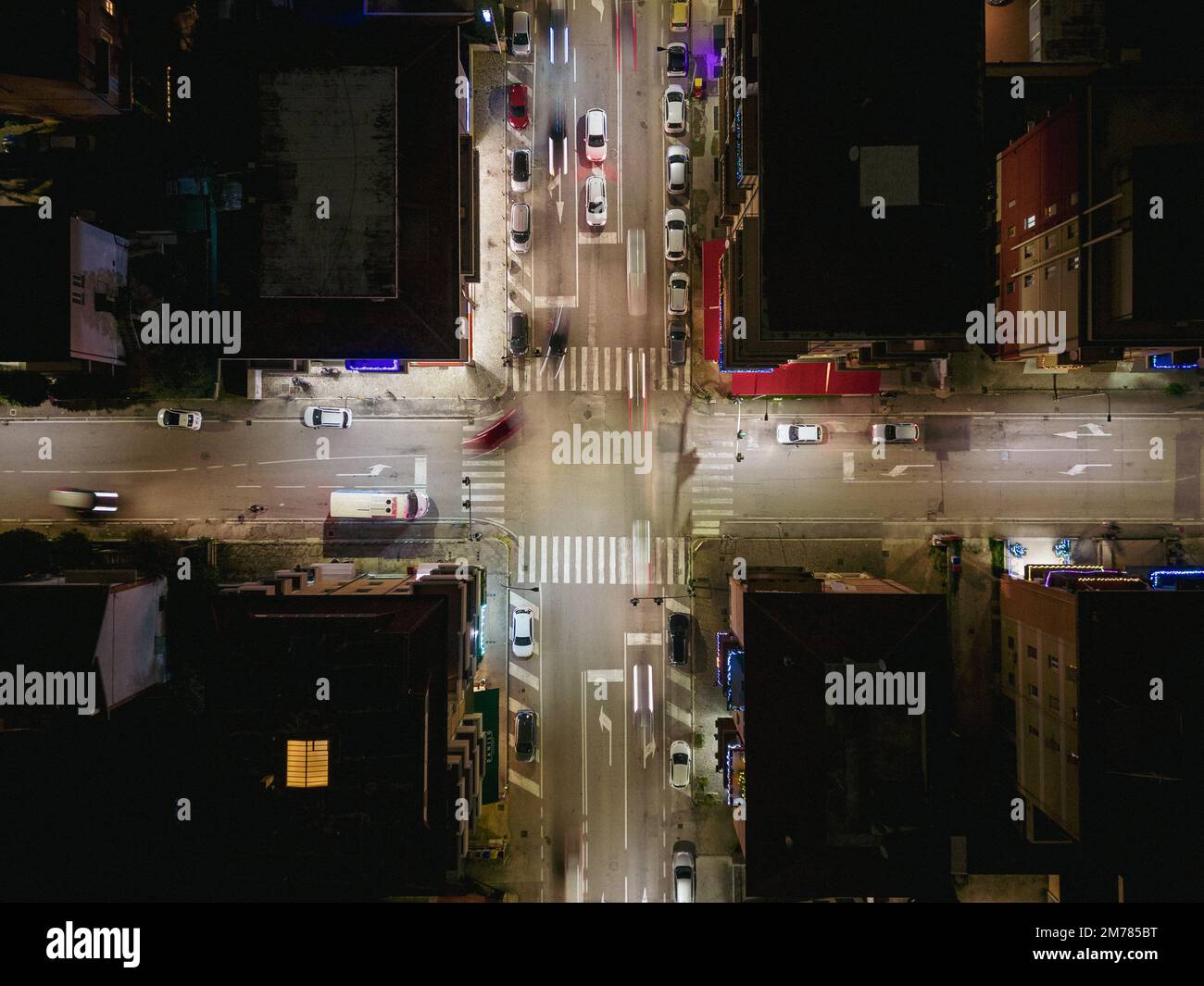 night view of a road busy with cars regulated by a roundabout. the slow ...